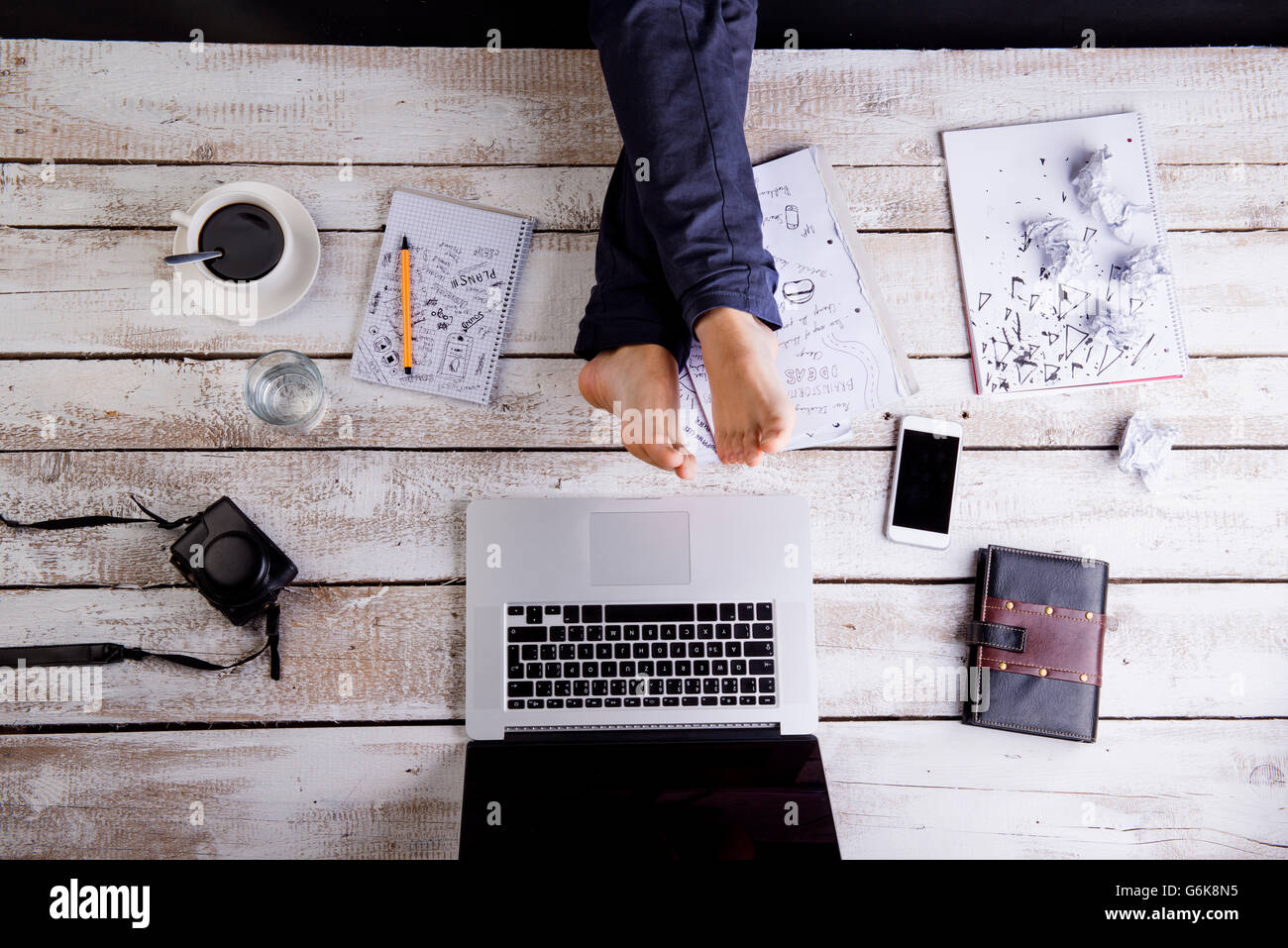 Man taking a break at desk with feet up in front of laptop Stock Photo ...
