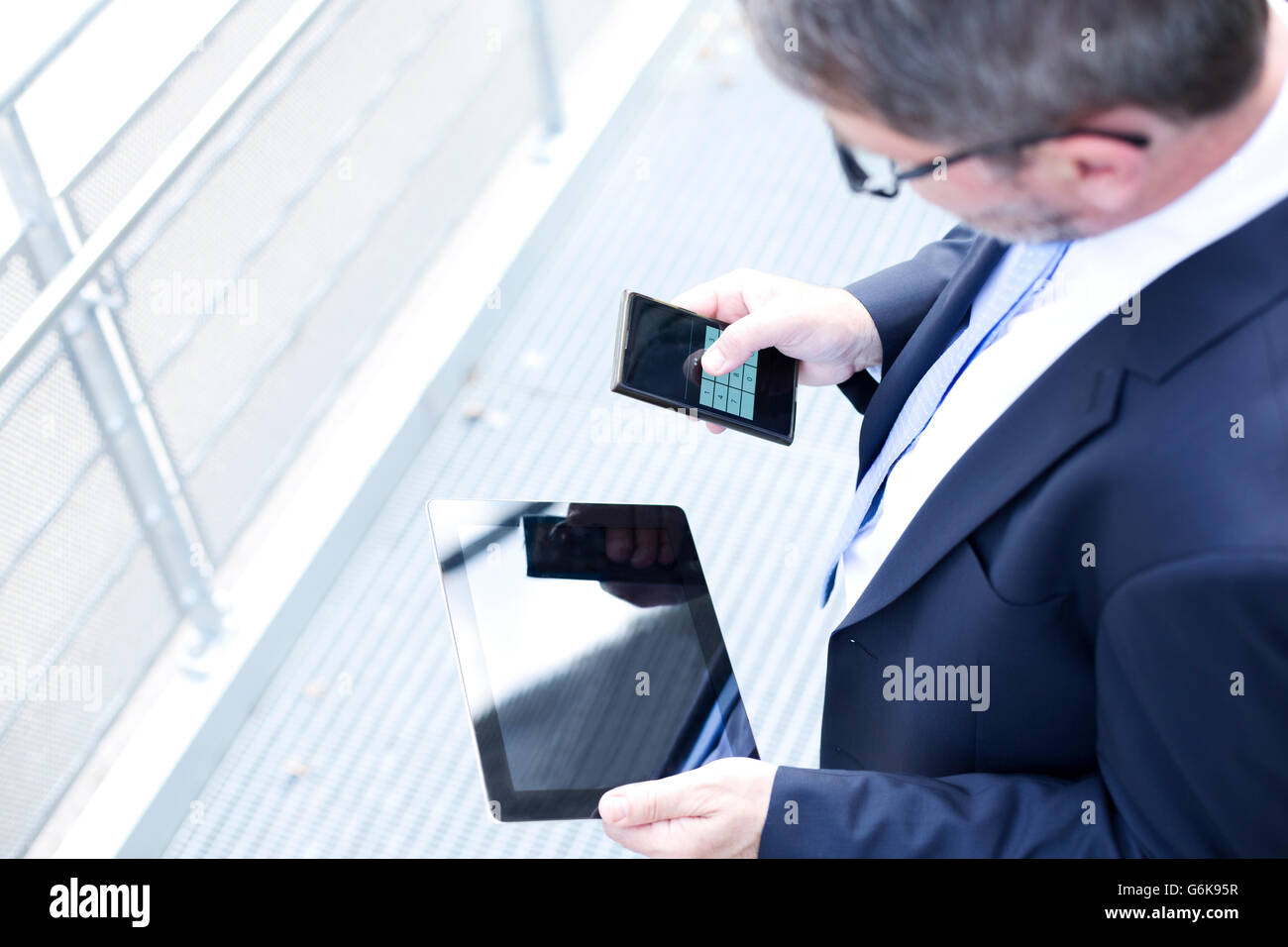 Businessman using smartphone outdoors Stock Photo - Alamy