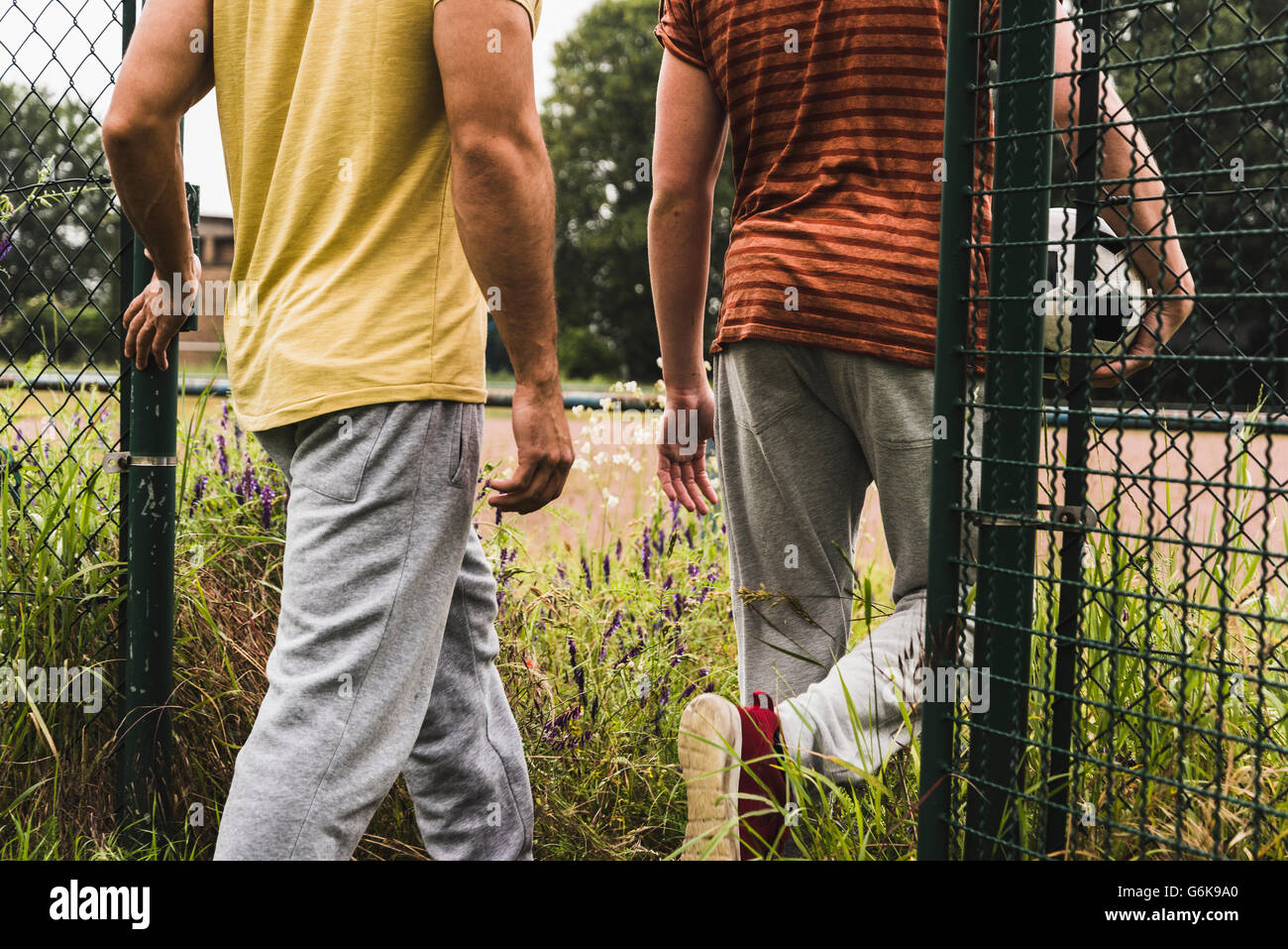 Close-up of two men entering football ground Stock Photo - Alamy