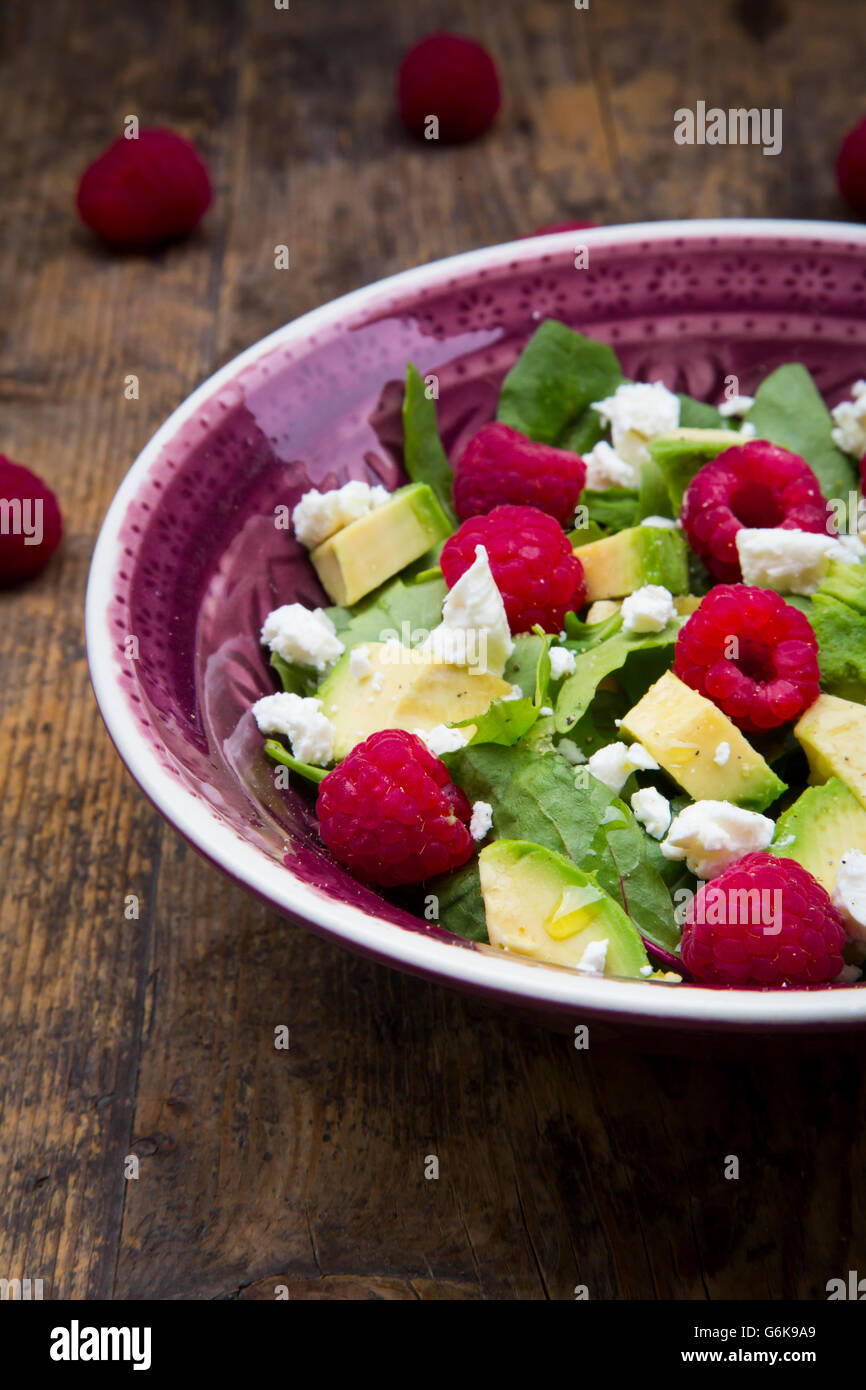 Bowl of avocado raspberry salad with feta, close-up Stock Photo - Alamy