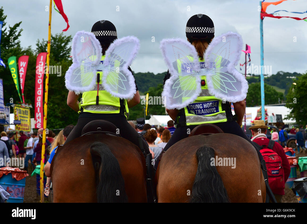 Police officers on horseback wearing angel wings at the Glastonbury ...