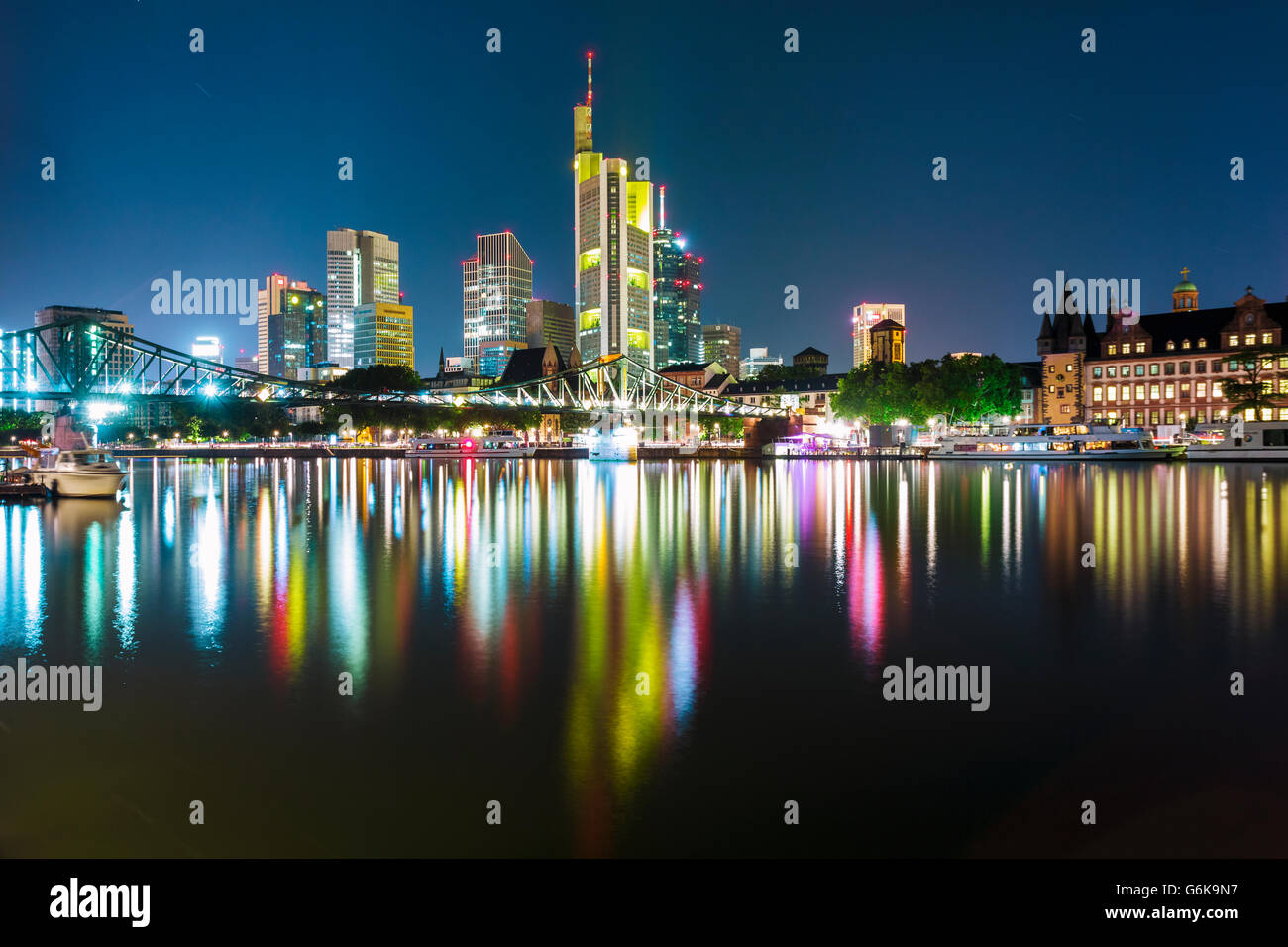 Germany, Frankfurt, lighted skyline with Main River in the foreground ...