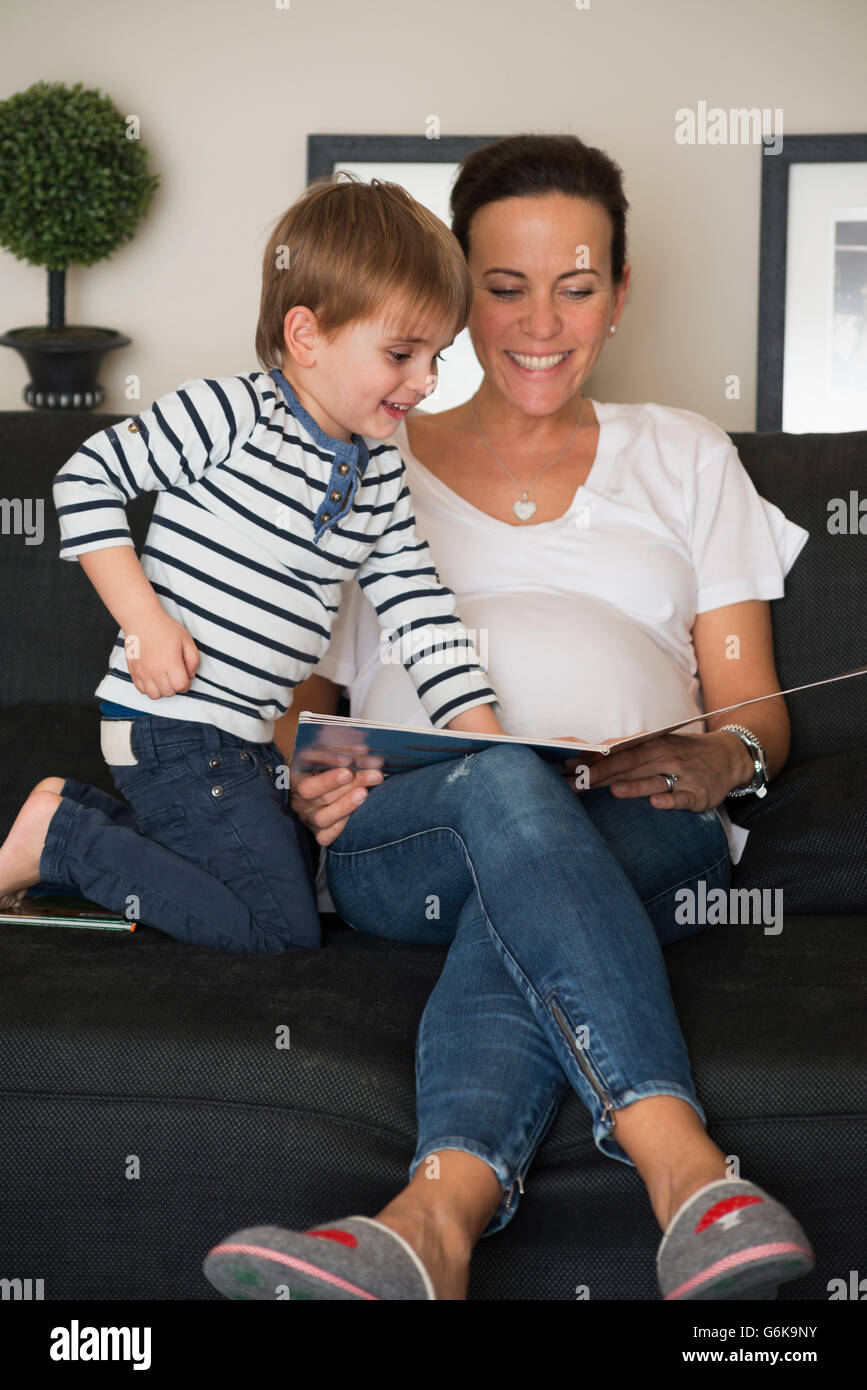 Mother reading book with her sons Stock Photo - Alamy