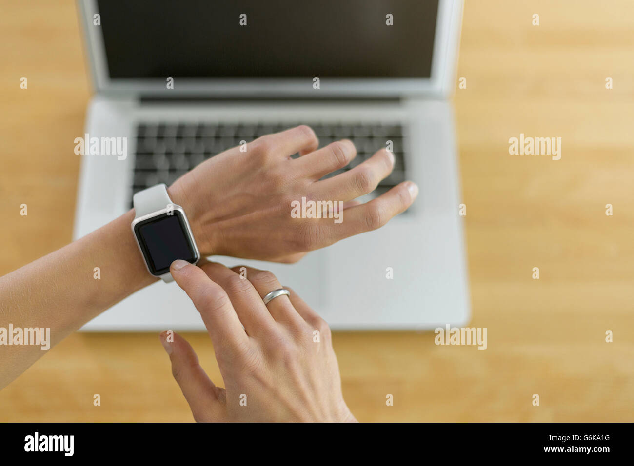 Woman with smartwatch and laptop Stock Photo - Alamy