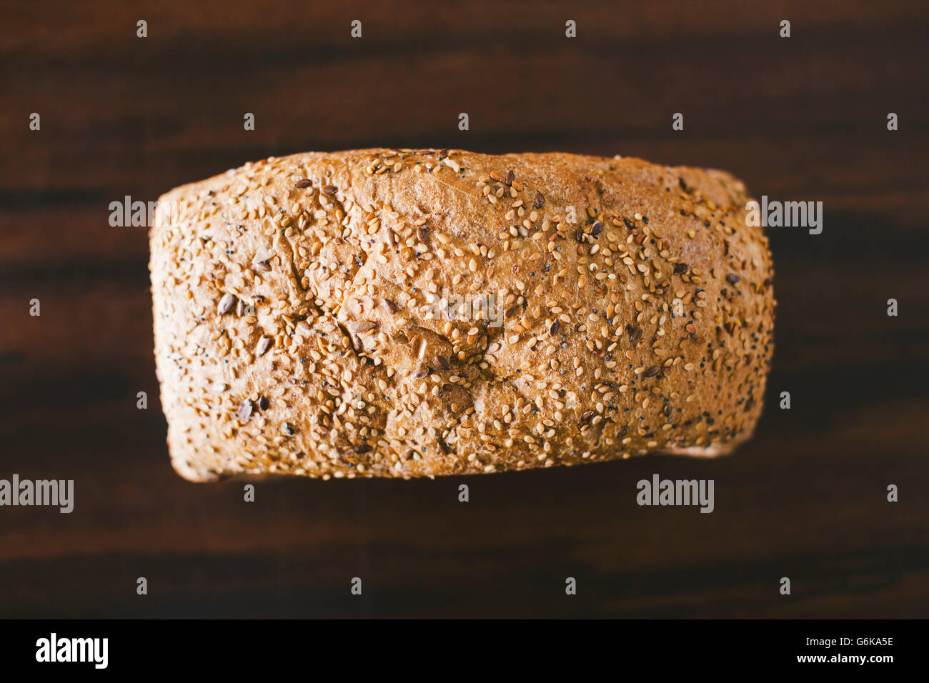 Hand made loaf of bread with seeds on wood Stock Photo - Alamy