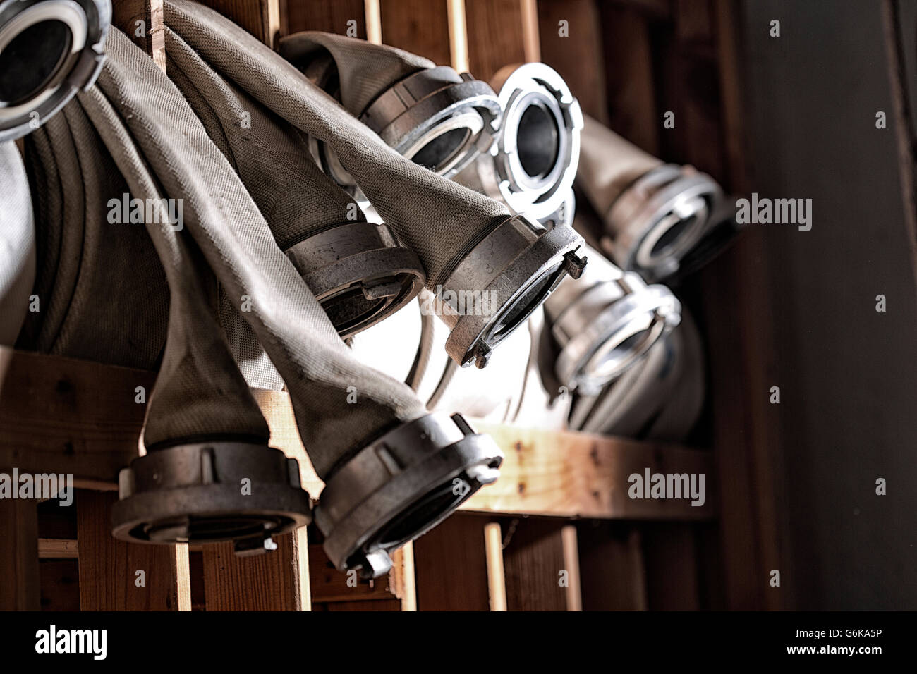Fire hoses in fire brigade equipment house Stock Photo - Alamy