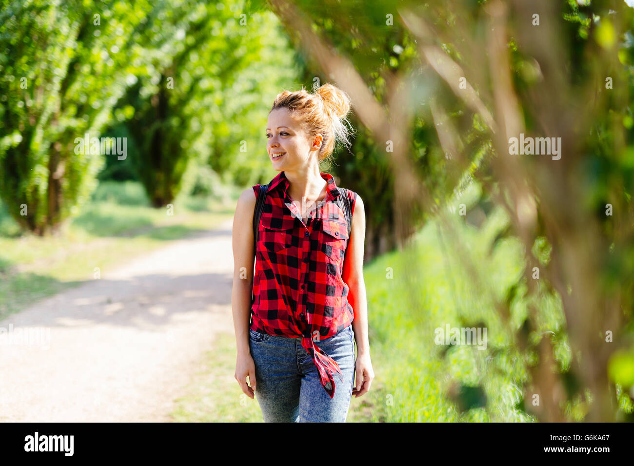 Smiling woman walking in nature Stock Photo - Alamy