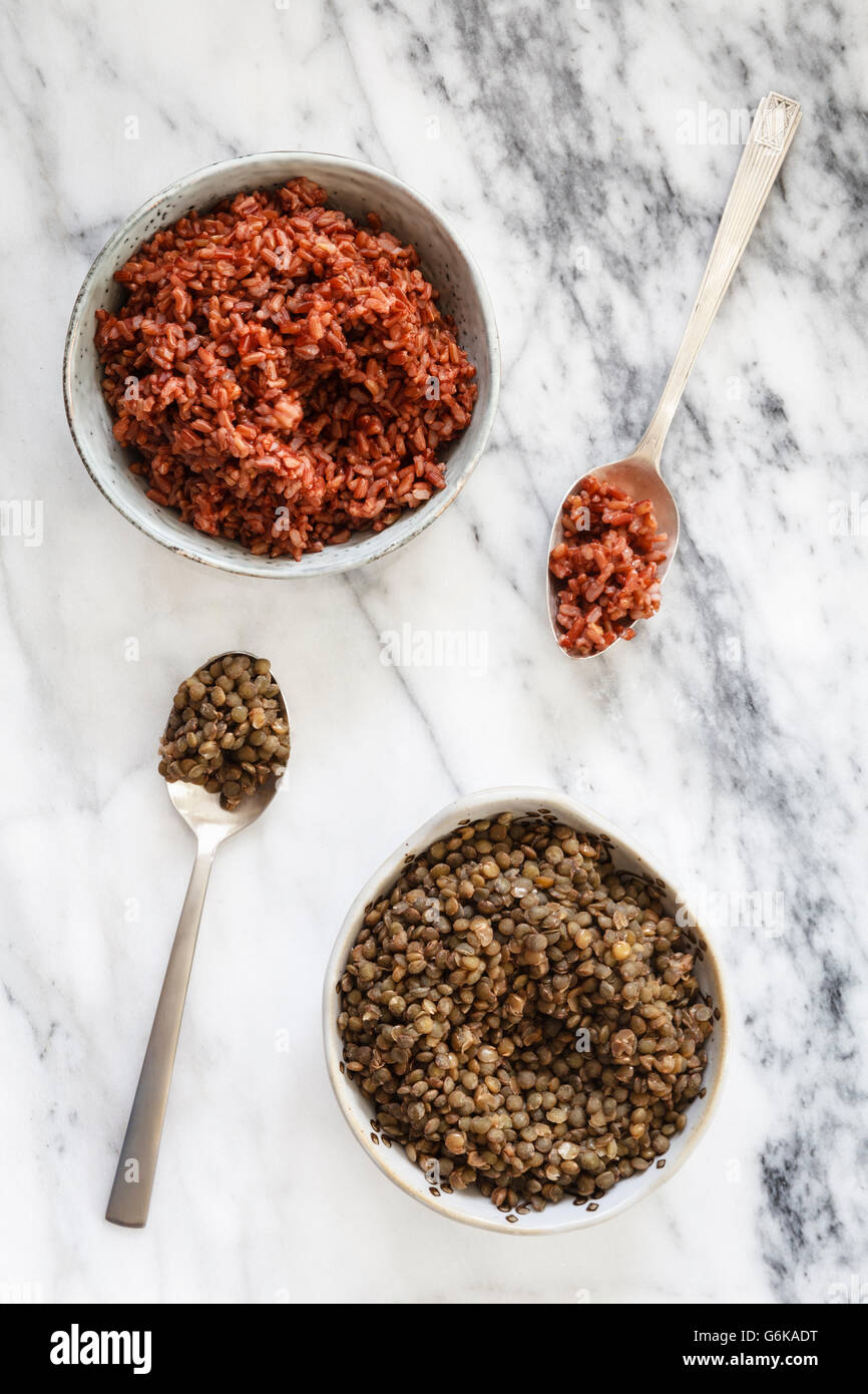 Bowls of boiled red rice andpuy lentils Stock Photo - Alamy