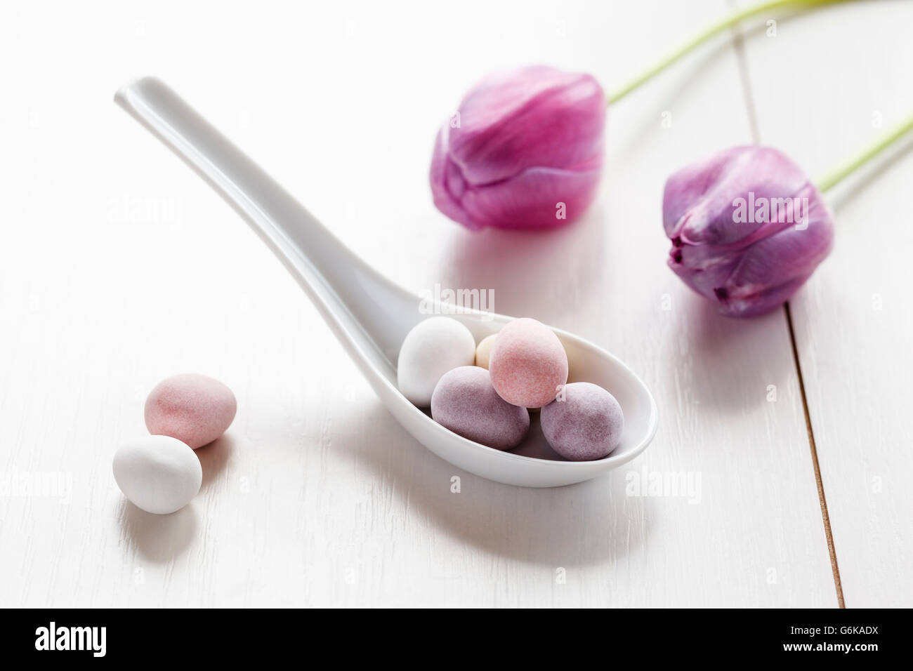 Chocolate Easter egg on porcelain spoon, tulips Stock Photo - Alamy
