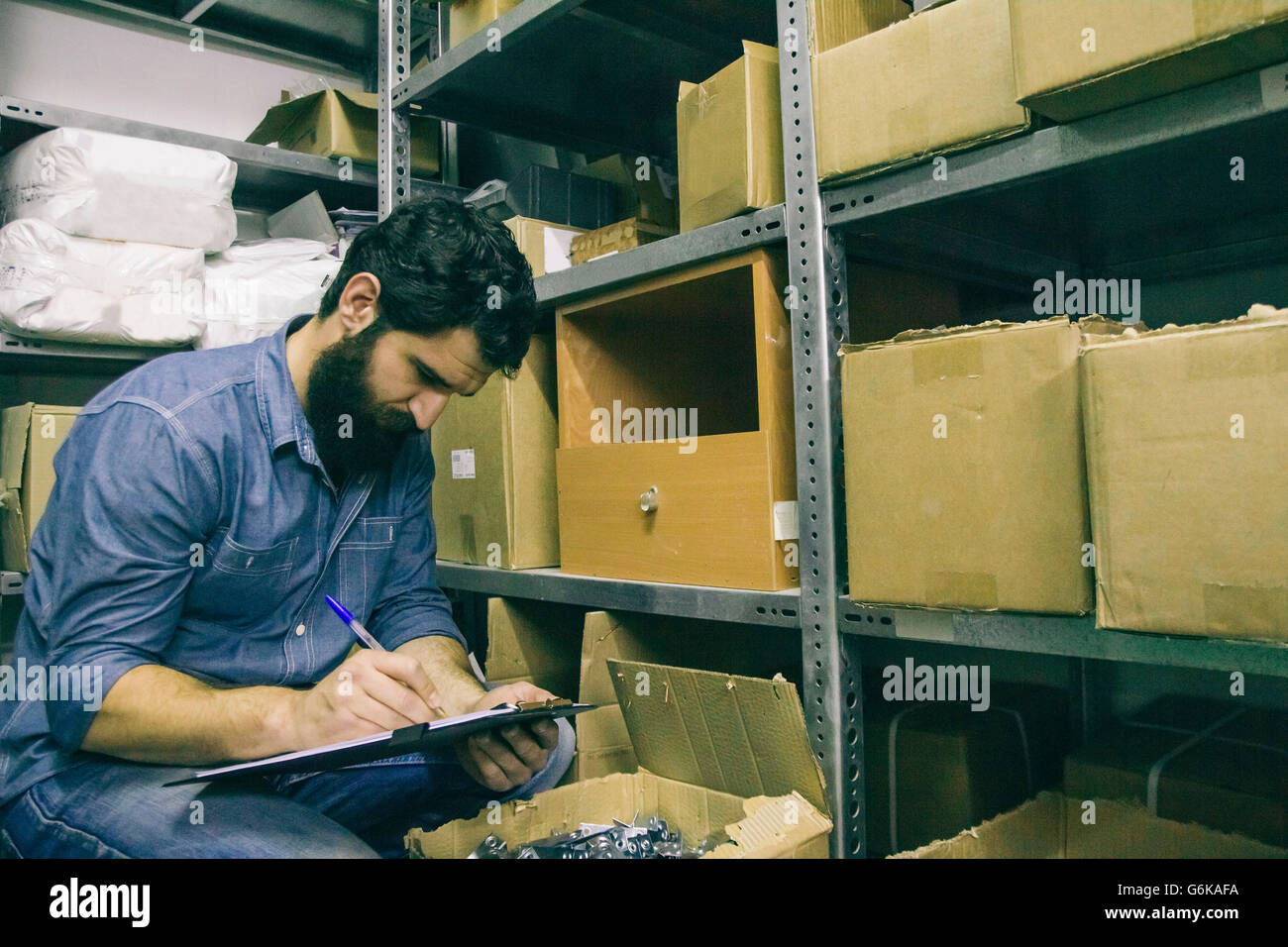 Manan examining business inventory hi-res stock photography and images ...