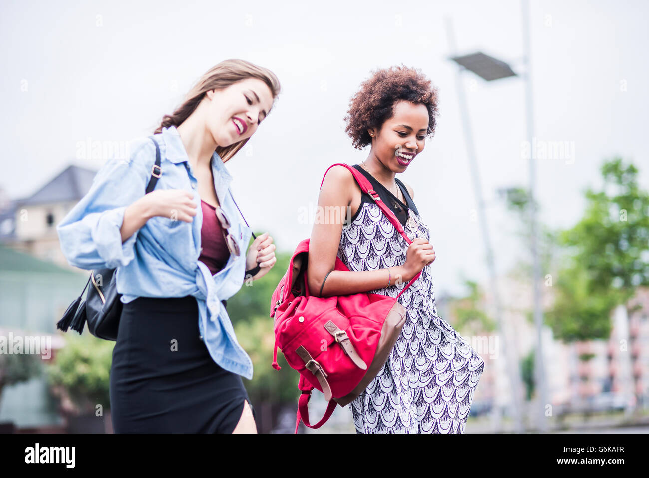 Two best friends walking and talking Stock Photo - Alamy