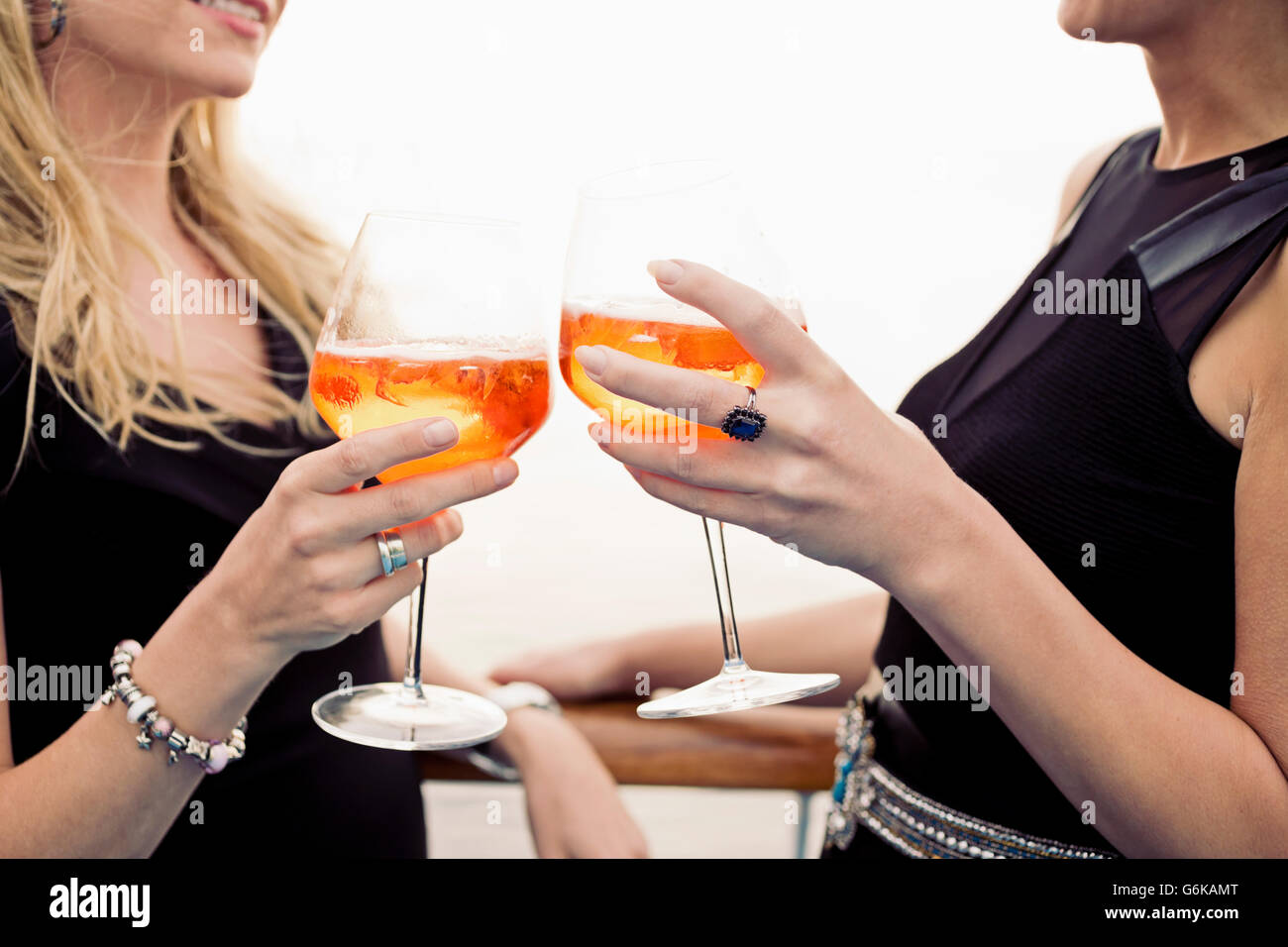 Two women toasting with aperitive hi-res stock photography and images ...