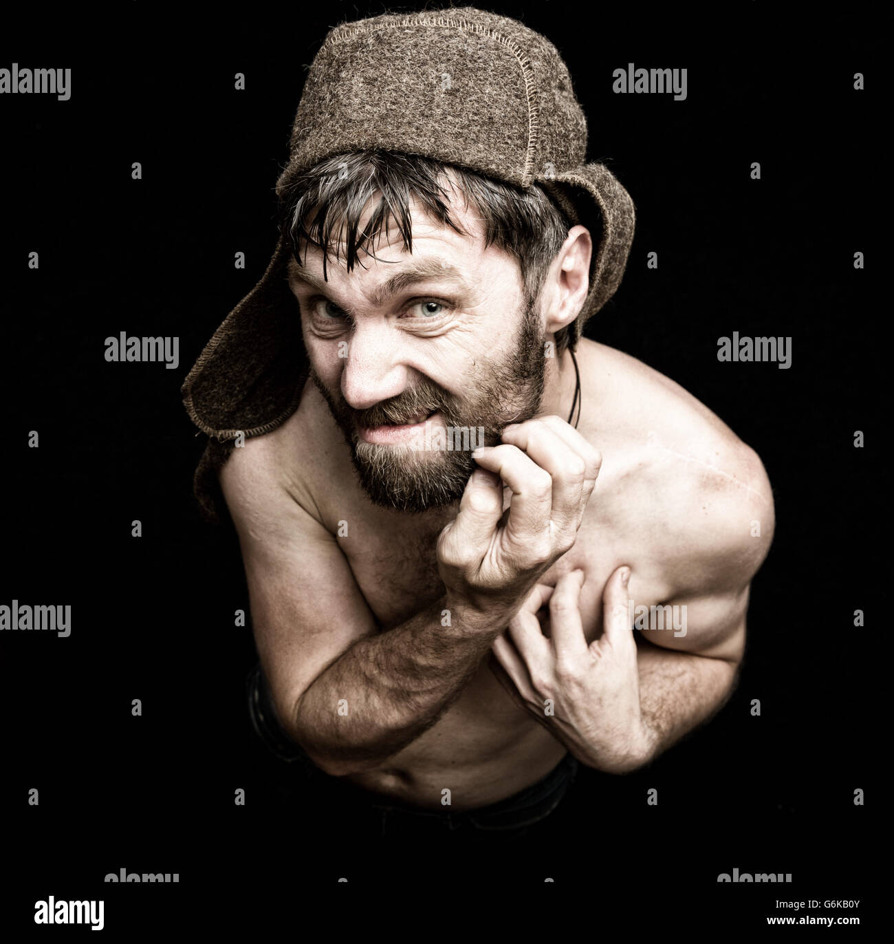 Dark portrait of scary evil sinister bearded man with smirk, makes ...