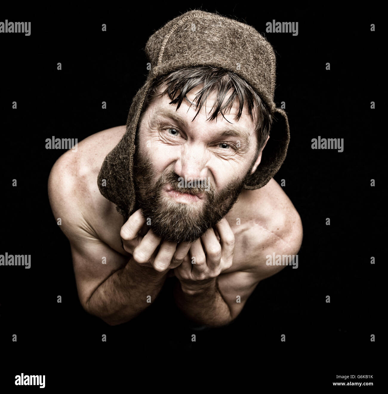 Dark portrait of scary evil sinister bearded man with smirk, makes ...