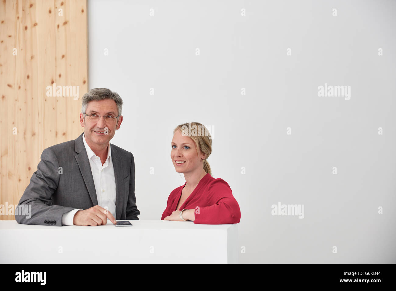 Mature manager working together with young collegue Stock Photo - Alamy