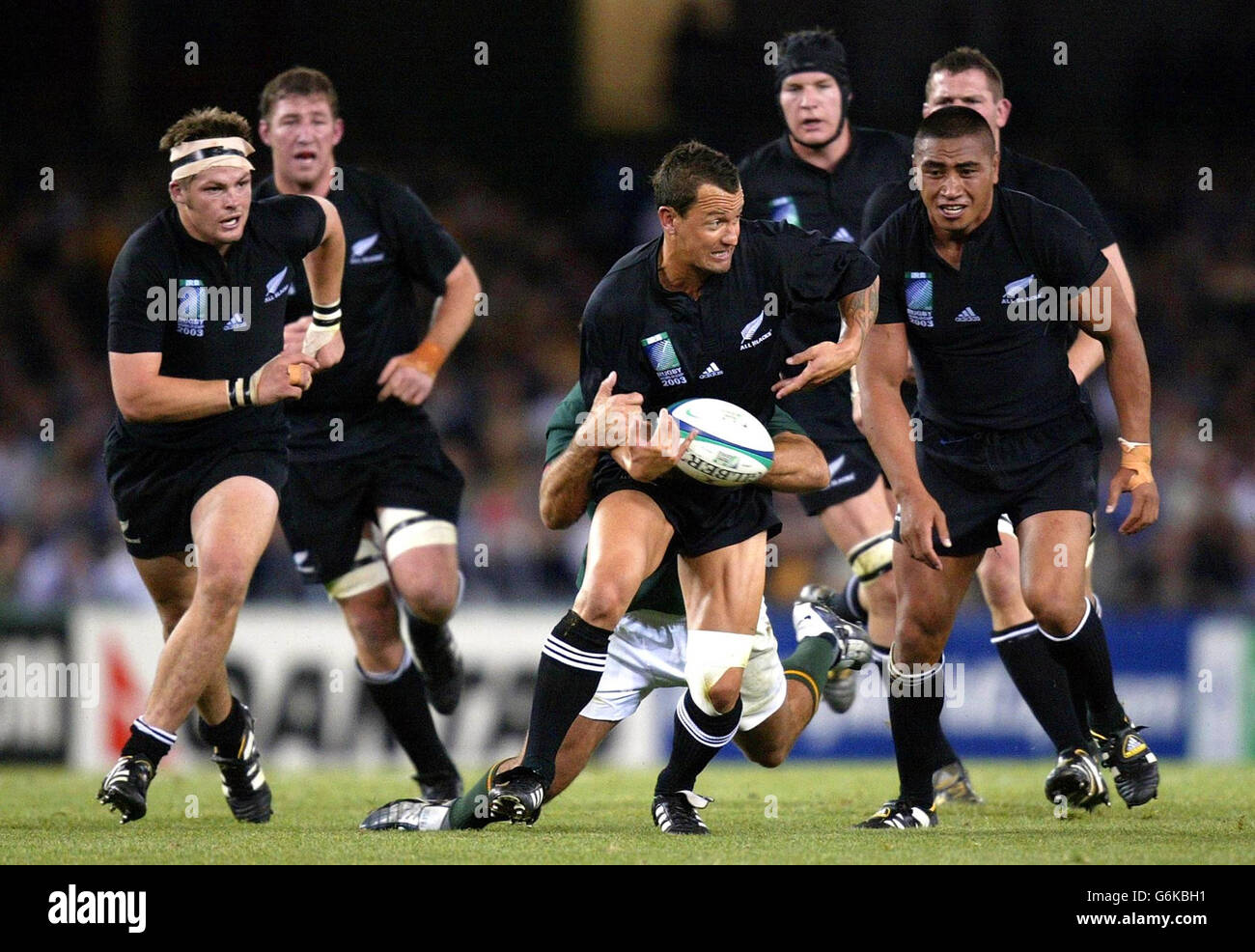 New Zealand's Carlos Spencer leads the All Blacks charge as he is ...