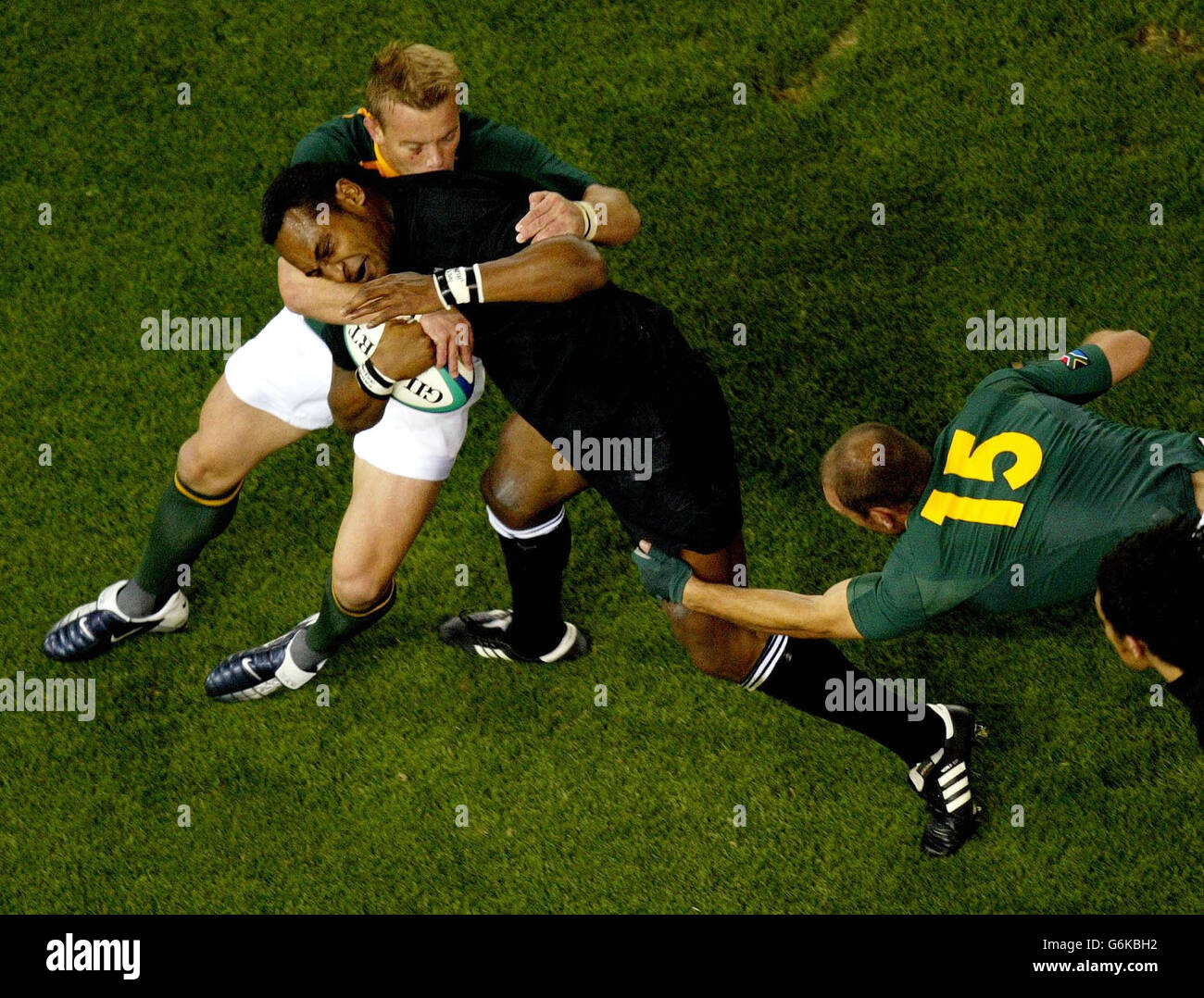 New Zealand's Joe Rokocoko is tackled by South Africa's Jorrie Muller ...