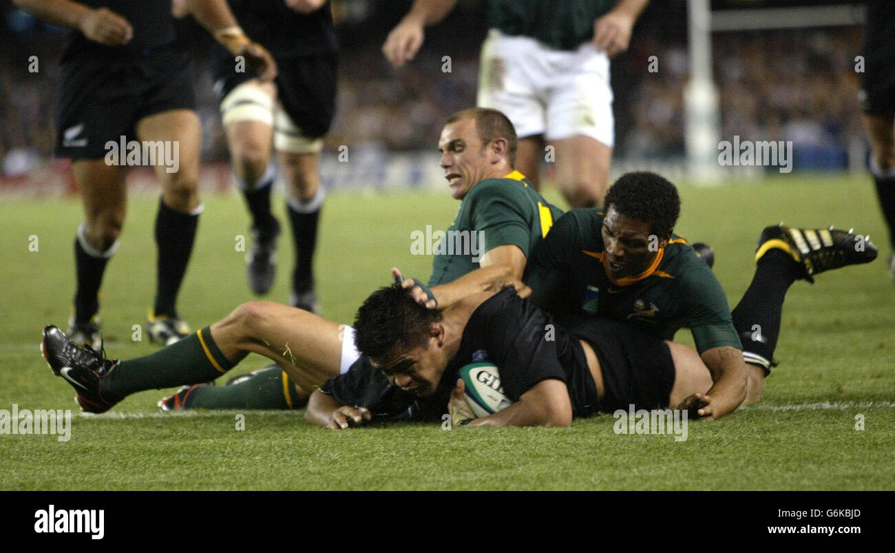 New Zealand's Keven Mealamu beats the tackles of Ashwin Willemse (right ...