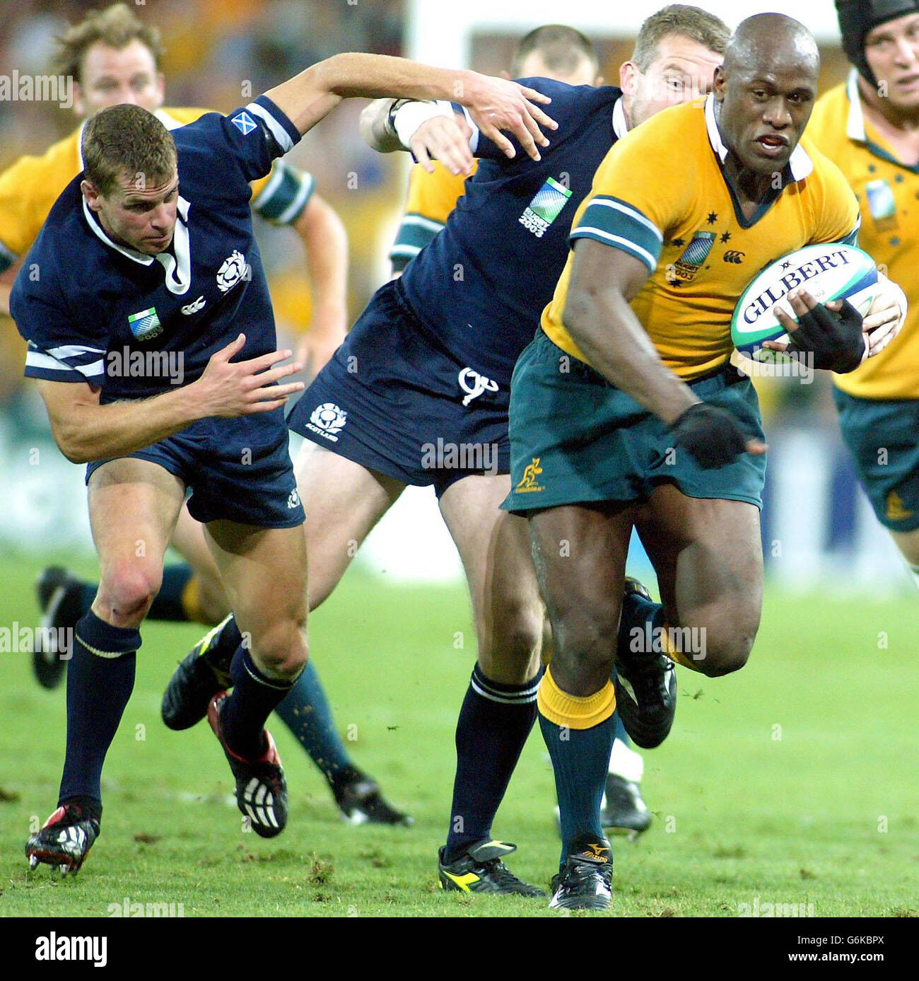 Australia's Wendall Sailor gets past Scotland's Chris Paterson (L) and ...