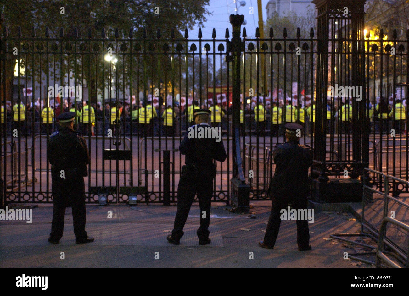 Demonstrators pass the gates of Downing Street on their way to a rally ...