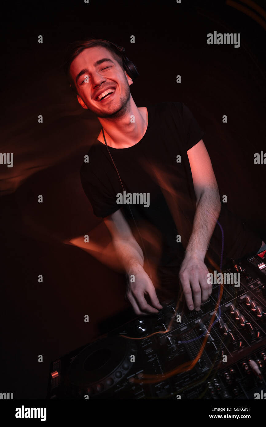 Cheerful young dj playing music and having fun Stock Photo - Alamy