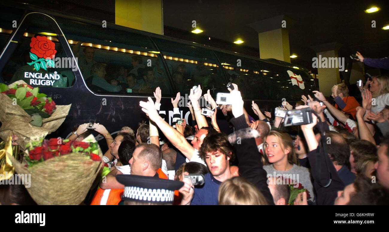 Fans surround the coach carrying the England rugby team at London's ...