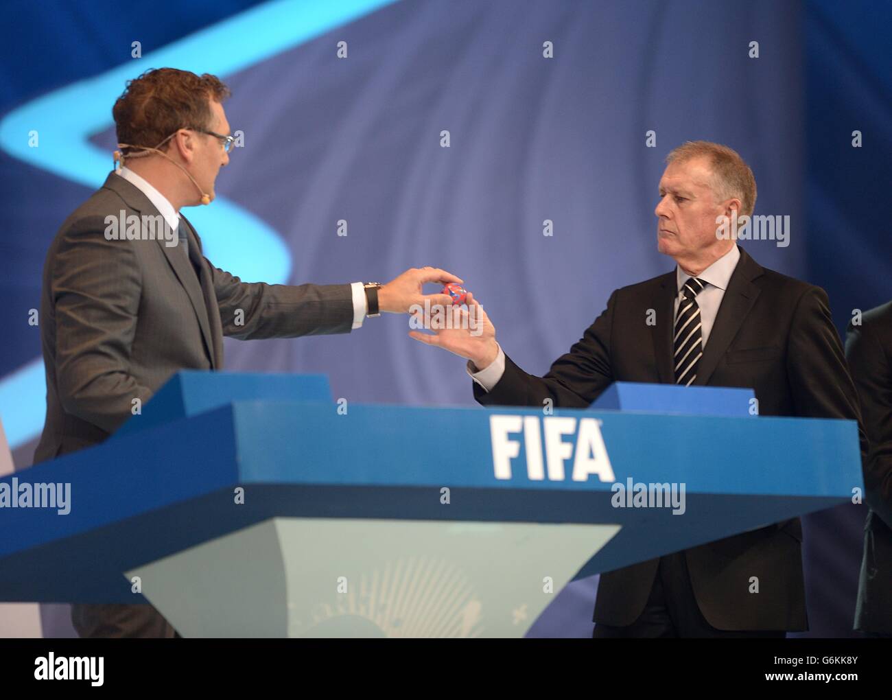 Former English footballer Geoff Hurst (right) hands a ball to FIFA ...