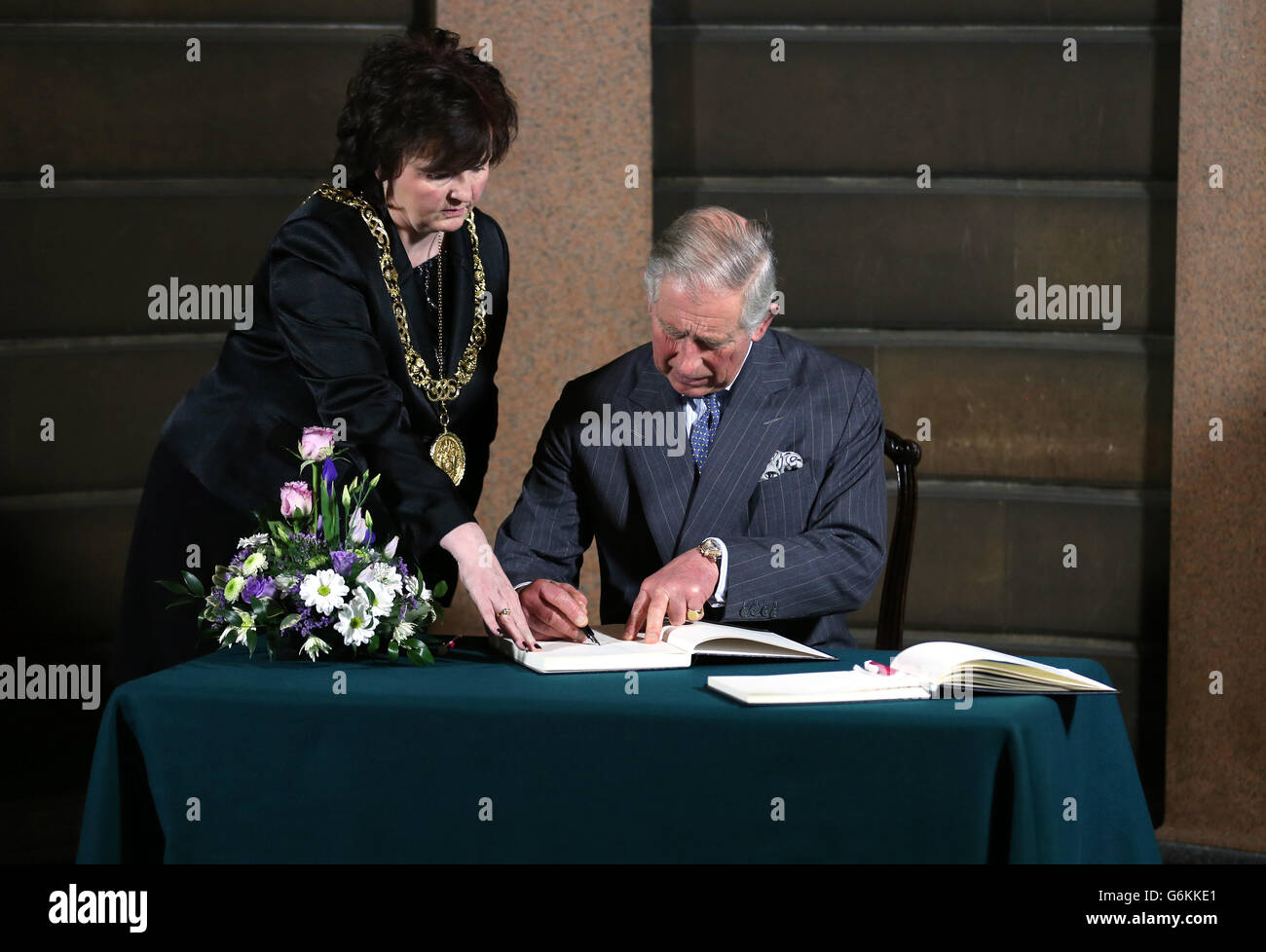 Prince Charles with Lord Provost Sadie Docherty as he signs a book of ...