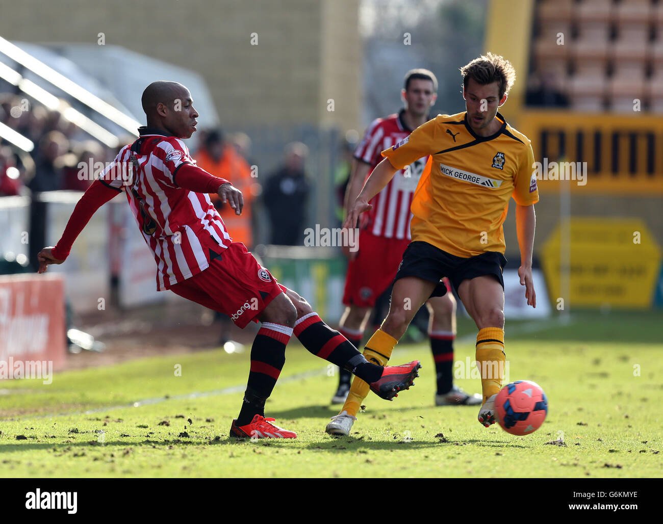 Cambridge United's Harrison Dunk (right) challenges Sheffield United's ...