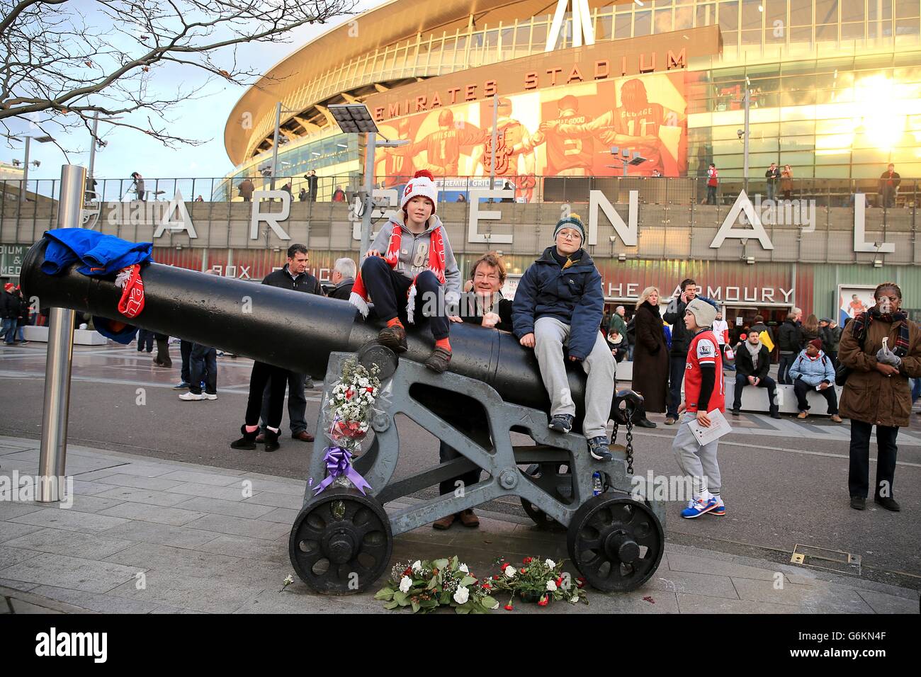 Fans pose for a photo outside the Emirates Stadium prior to kick-off ...