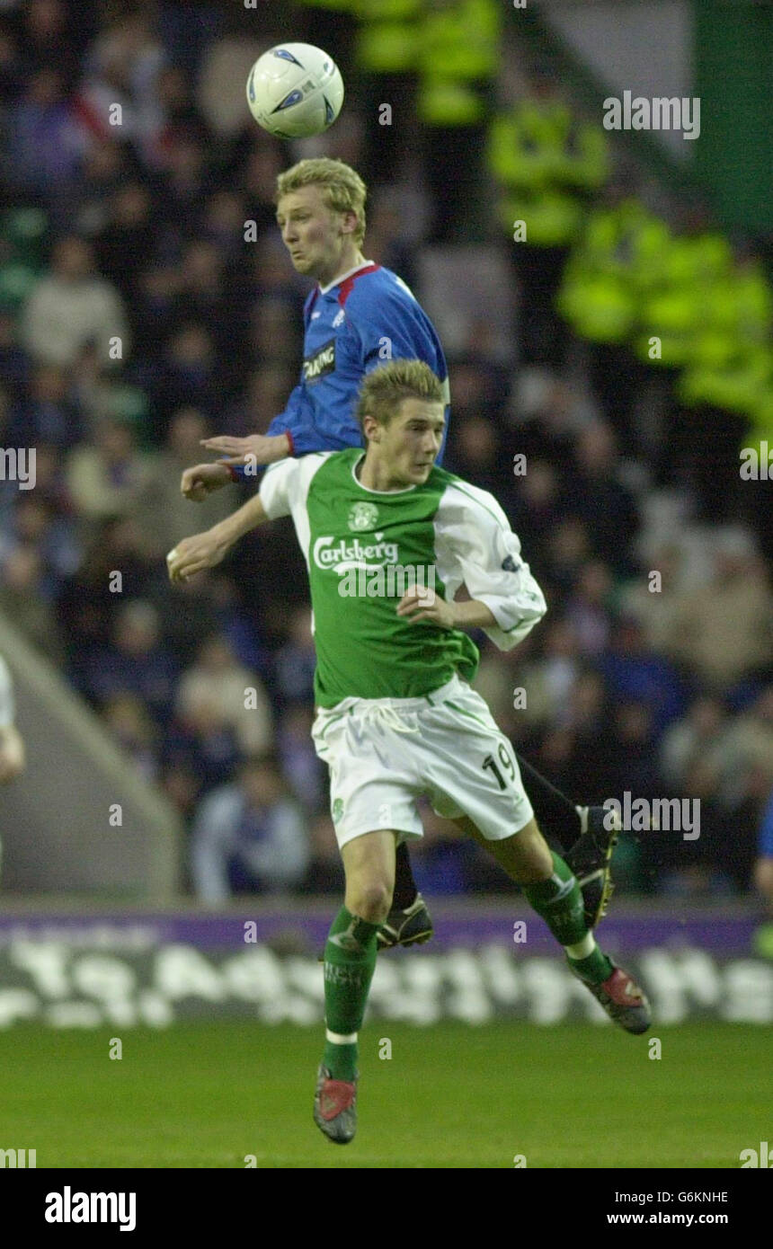 Rangers' Stephen Hughes (top) challenges Hibernian's Kevin Thomson ...