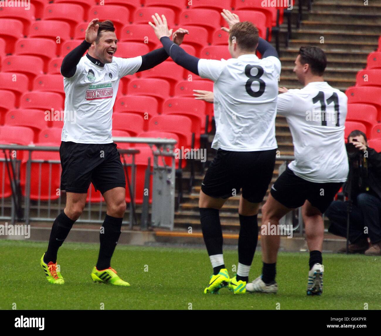 Mark Wright (left) celebrates scoring for team Grimshaw during the ...