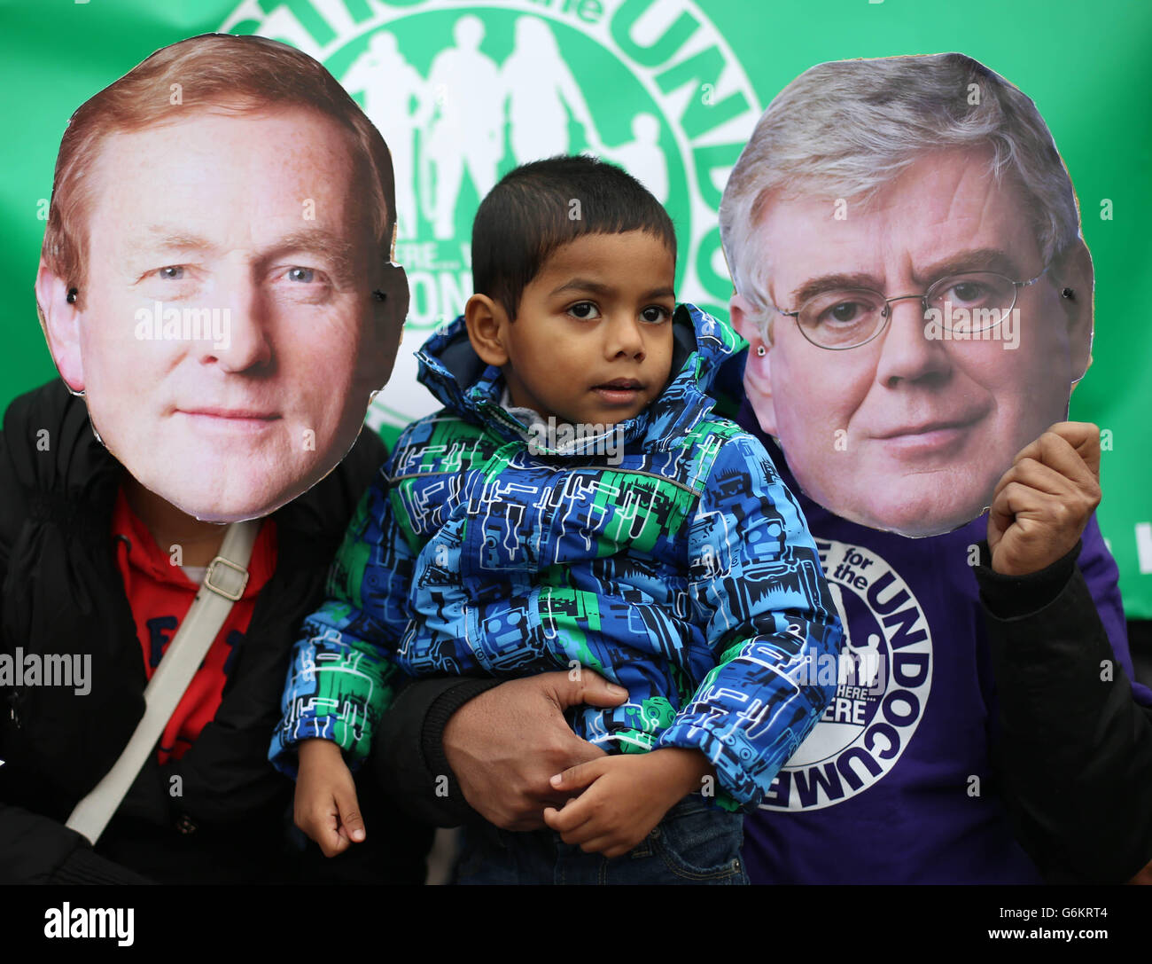 Ryan, age 3, poses for pictures with his parents (wearing masks of ...