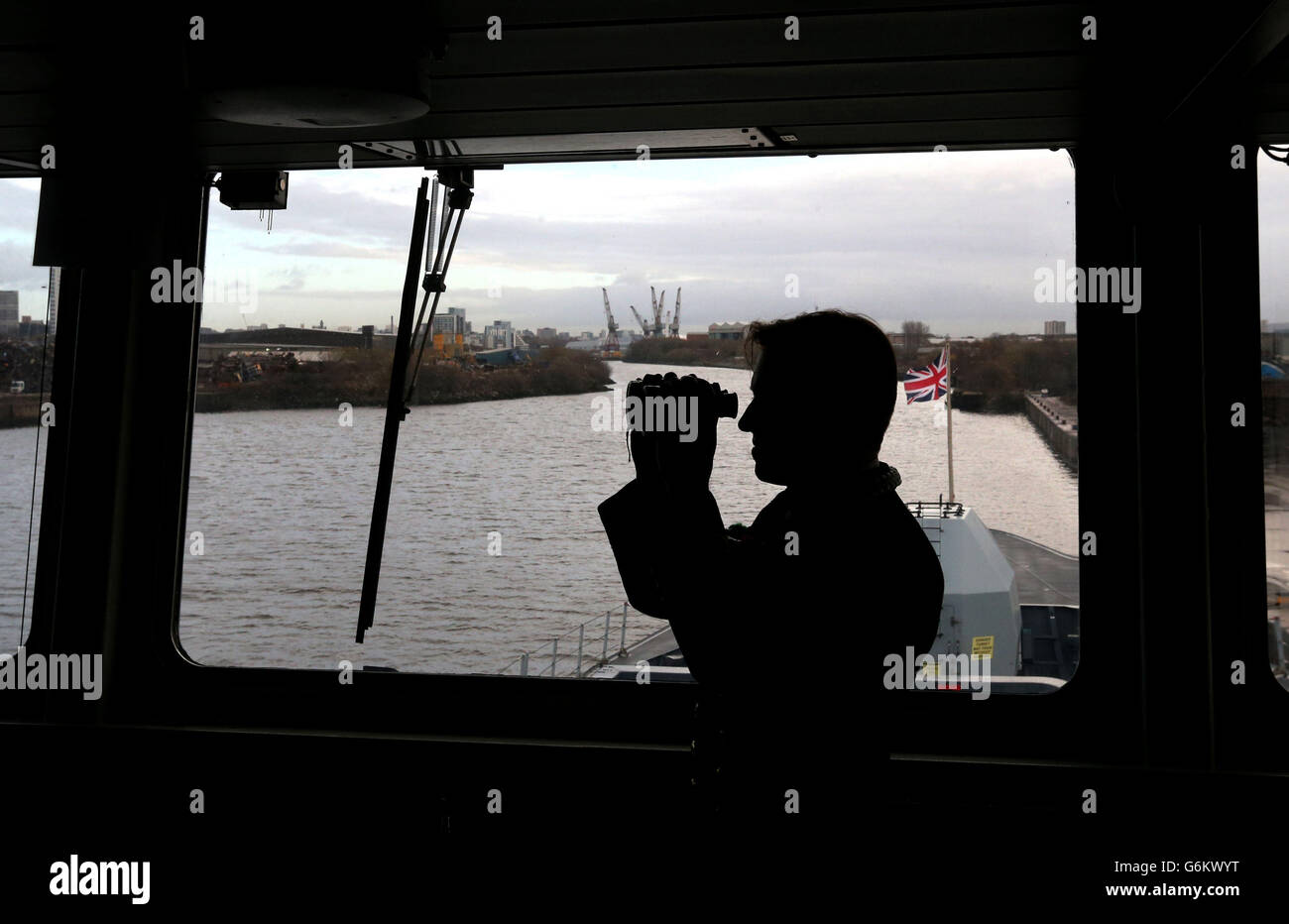 HMS Defender commanding officer Commander Philip Nash looks out from ...