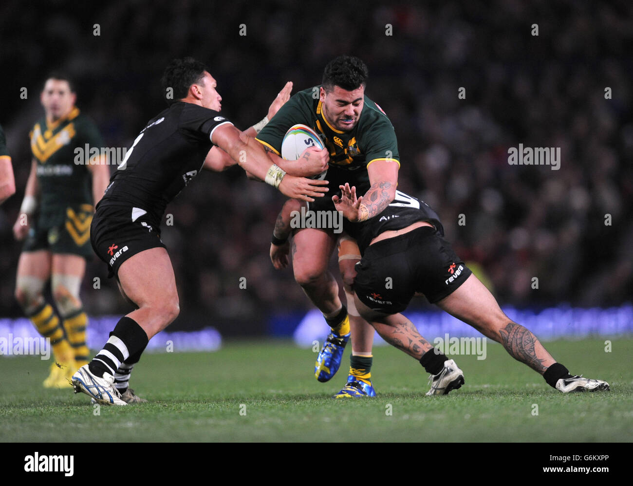 Australia's Andrew Fifita is tackled by New Zealand's Elijah Taylor ...