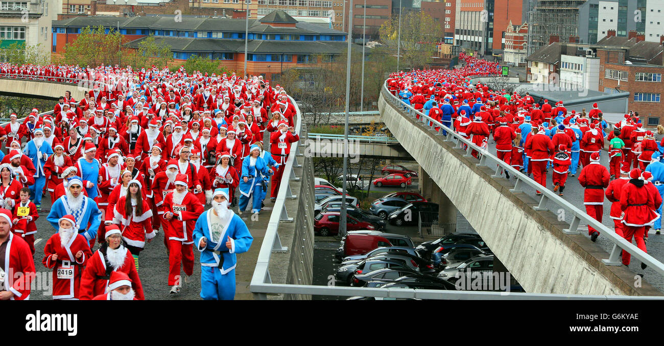 Runners dressed as Santa take part in the Liverpool Santa Dash, with an ...