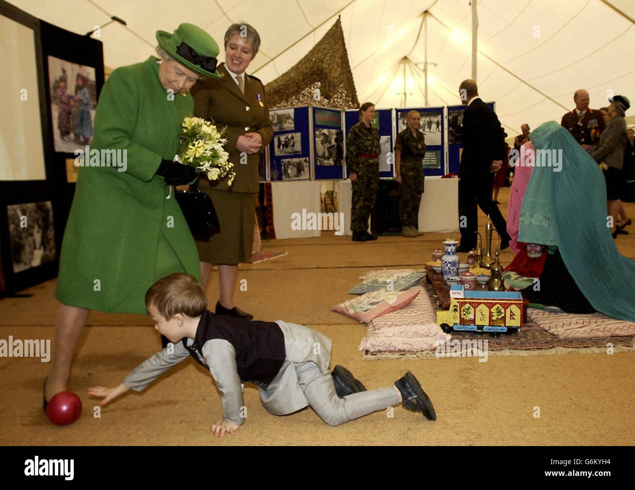 Queen Elizabeth II stops an errant ball as four-year-old Benjamin Pegg ...