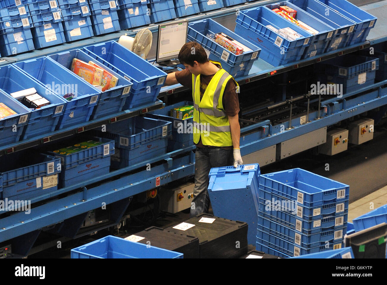 Workers prepare orders for delivery at the argos distribution centre hi ...