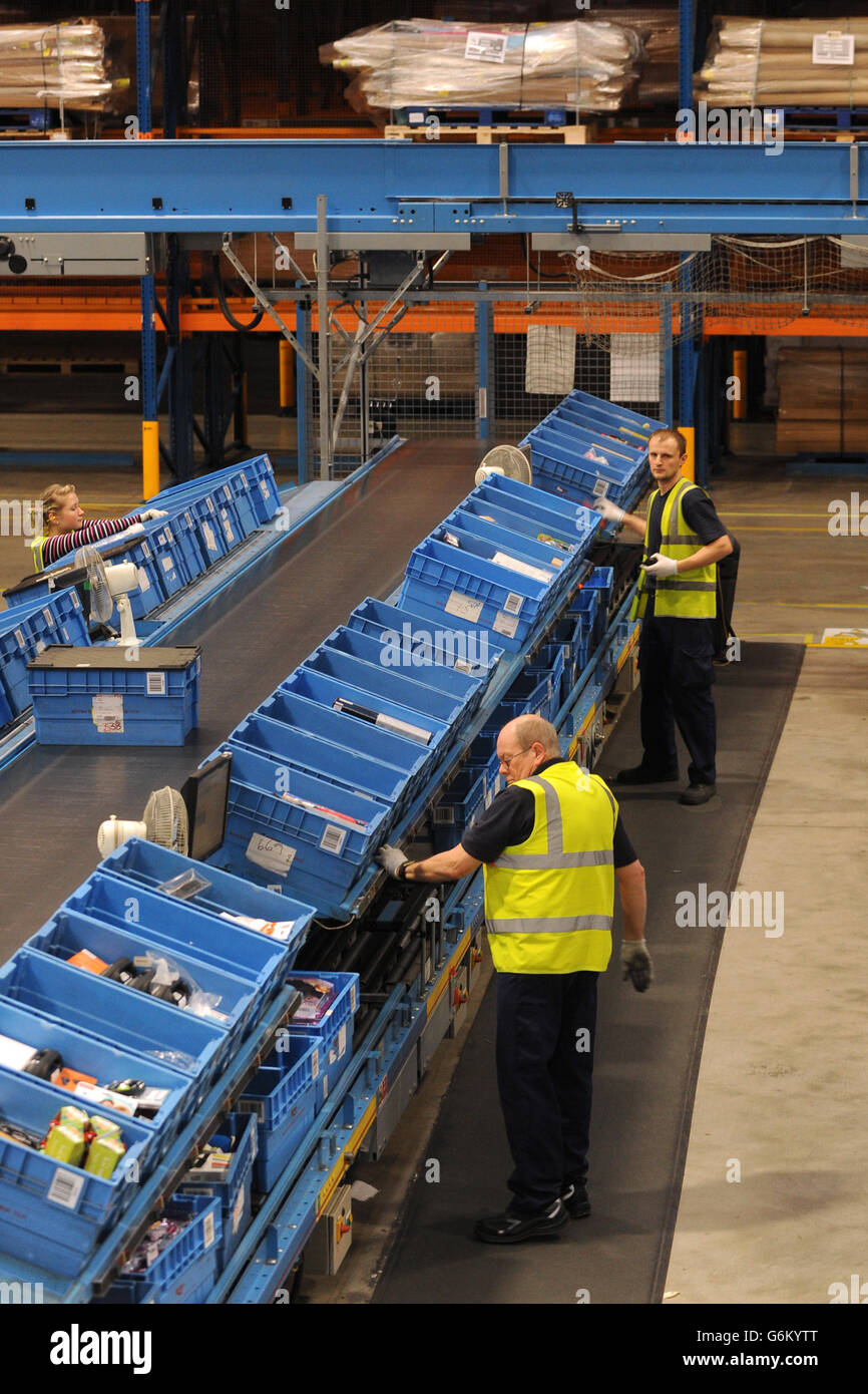 Workers prepare orders for delivery at the argos distribution centre hi ...