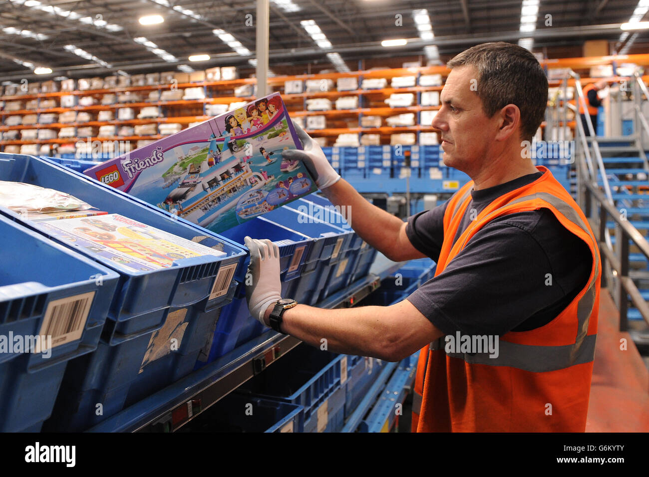 Martin Heywood places a Lego Friends toy into the relevant delivery ...