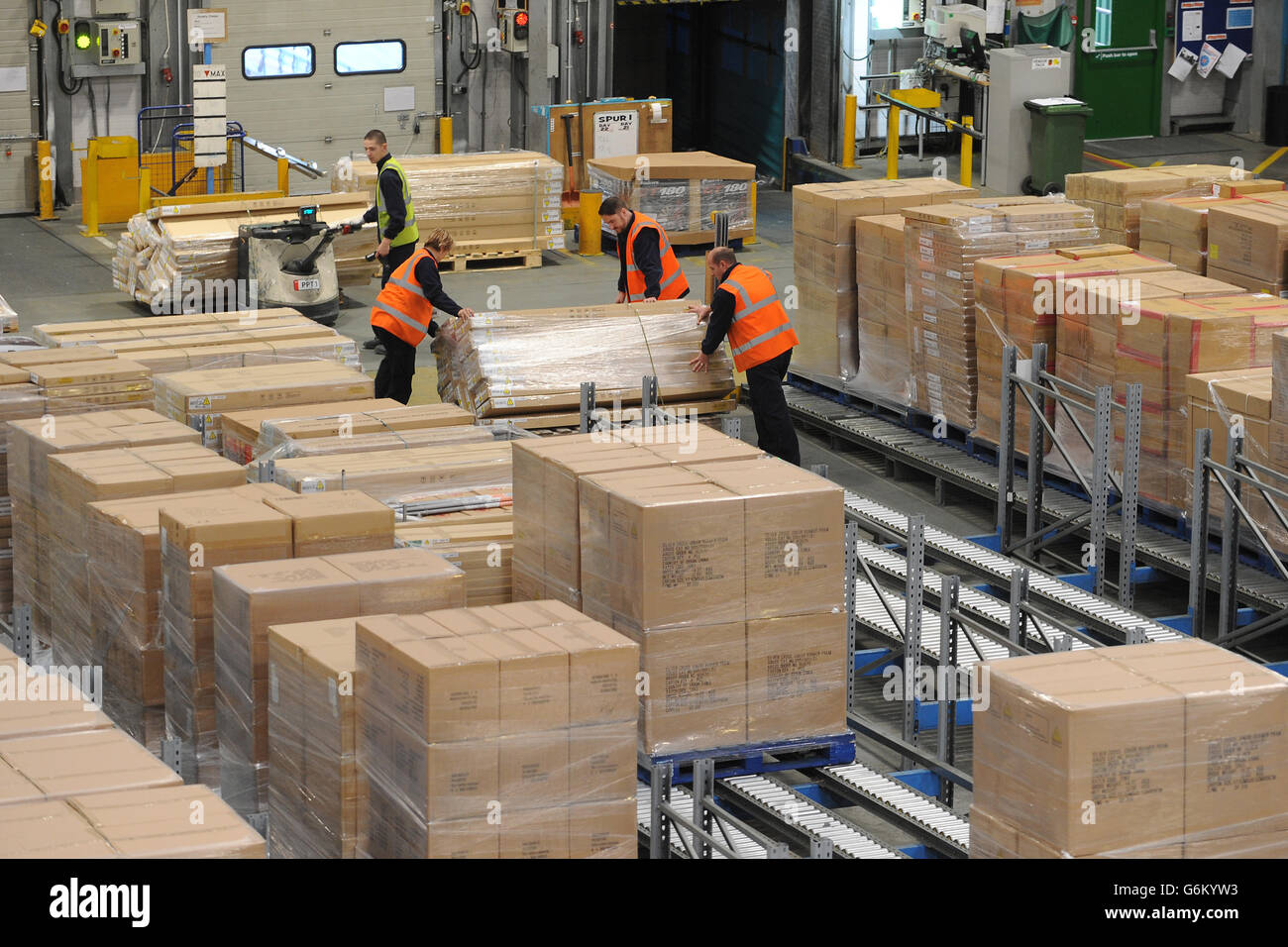 Workers prepare orders for delivery at the Argos distribution centre ...
