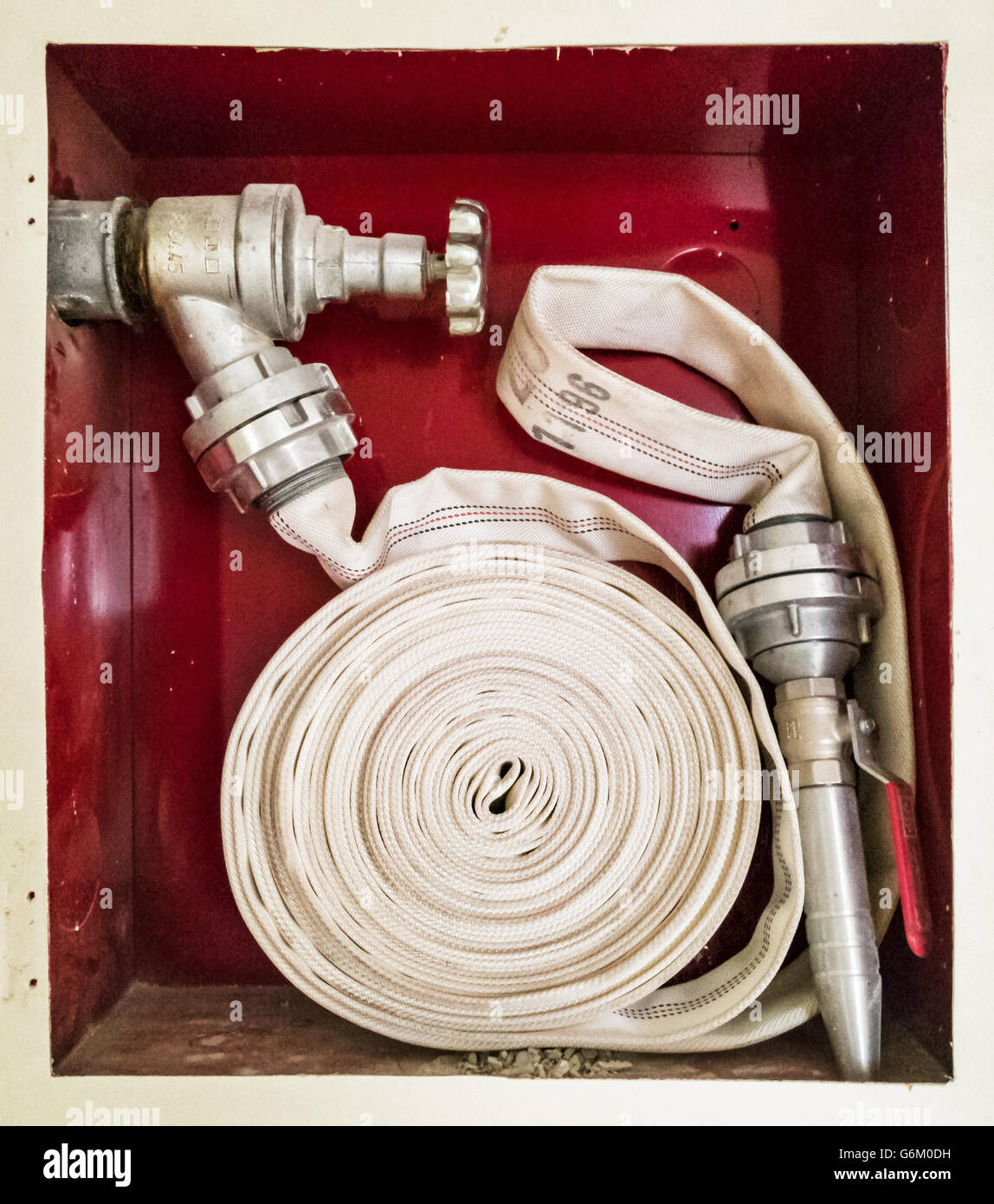 Fire cock with stacked hose. Water tap. Modern system. Iron hydrant ...