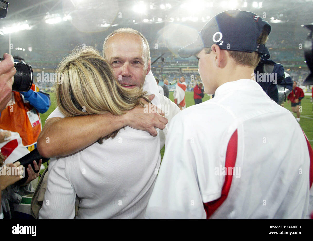 England coach Clive Woodward embraces his wife Jane as his son looks on ...