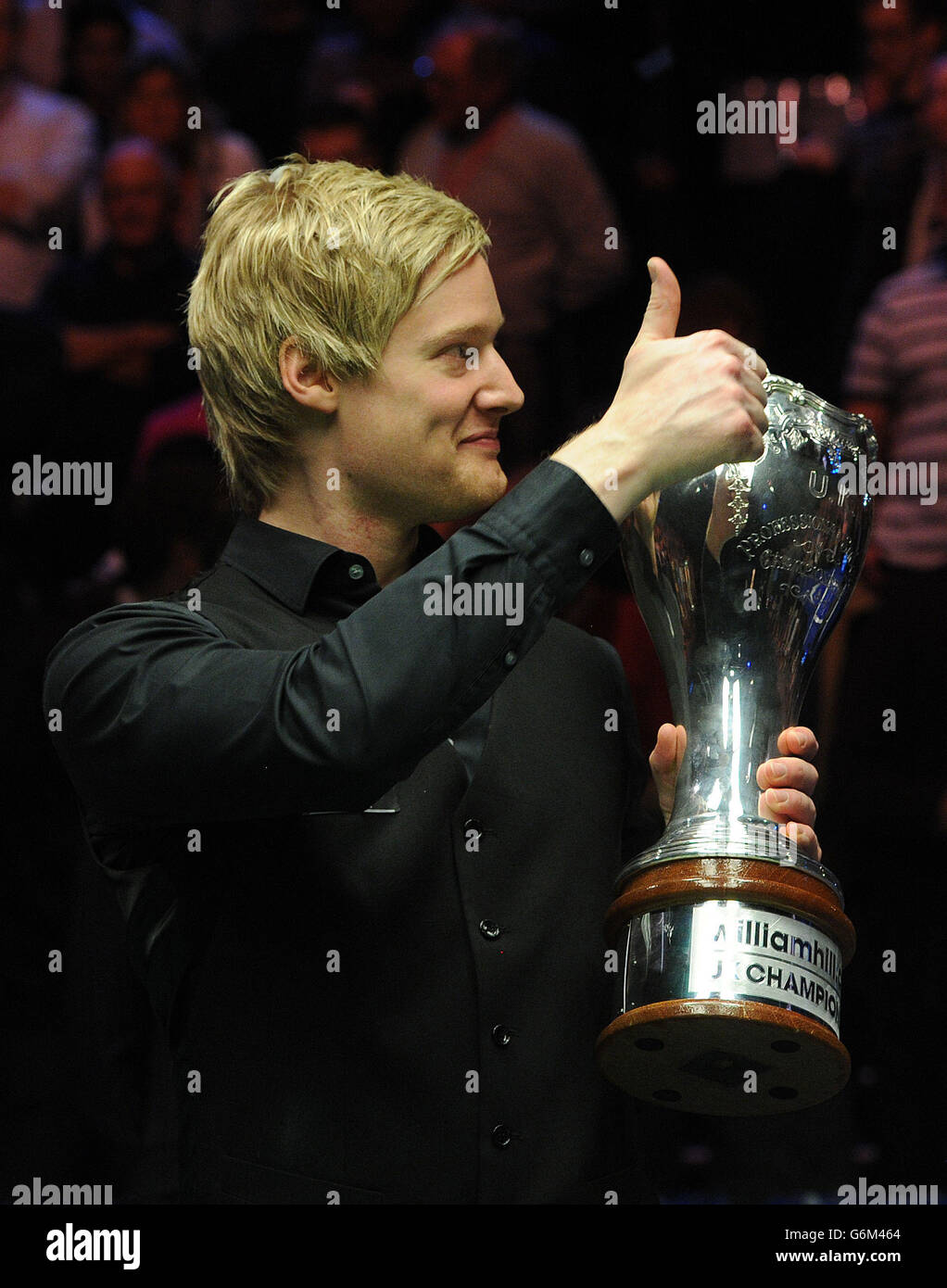 Neil Robertson celebrates with the trophy after winning the final match ...