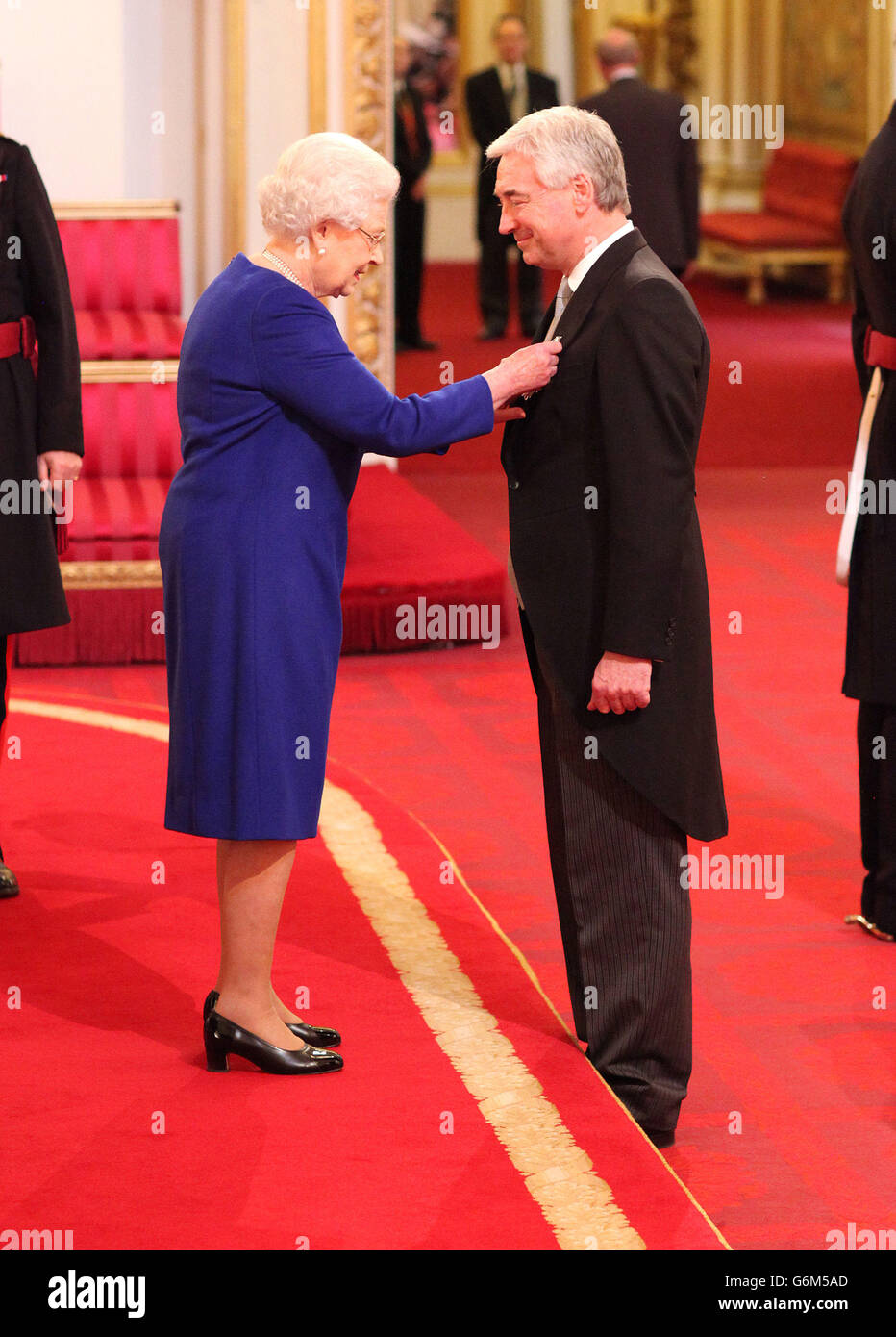 Mr. Paul Clark is made an MBE by Queen Elizabeth II at Buckingham ...