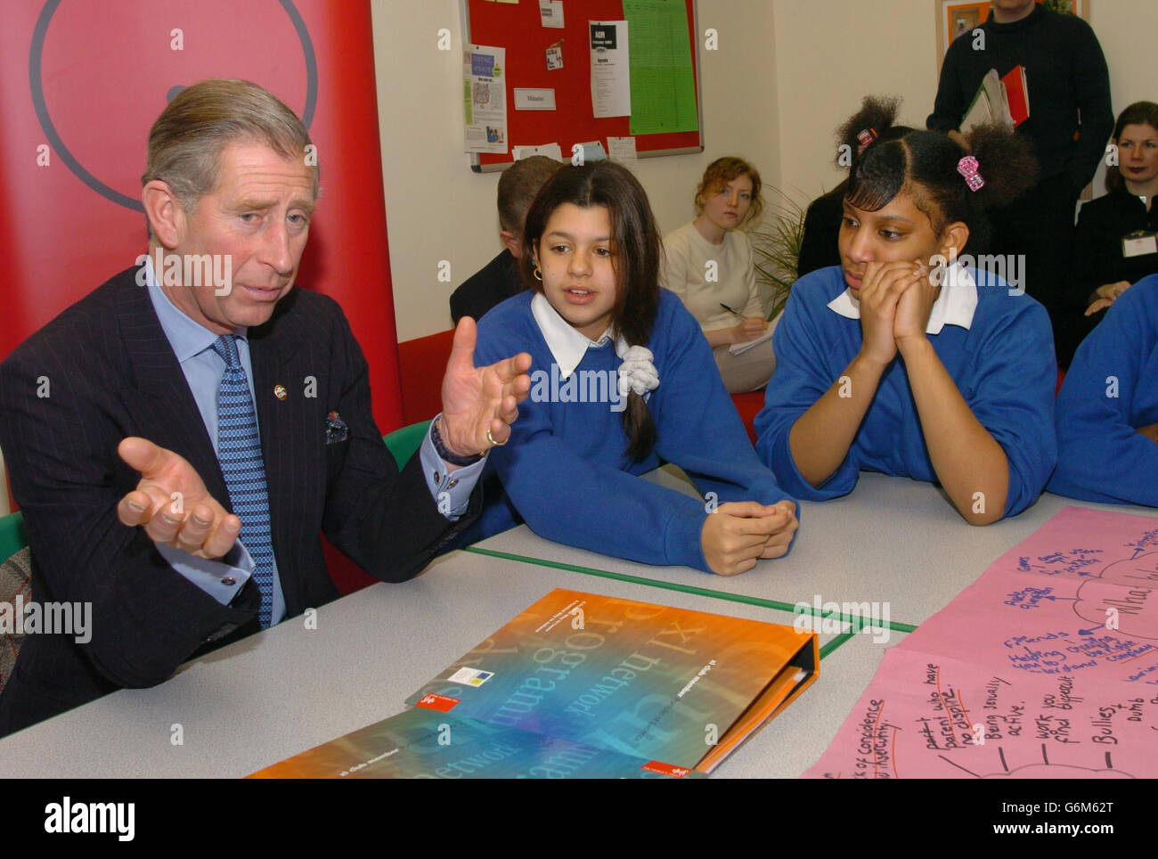 The Prince of Wales talks to children during a visit to Haggerston ...