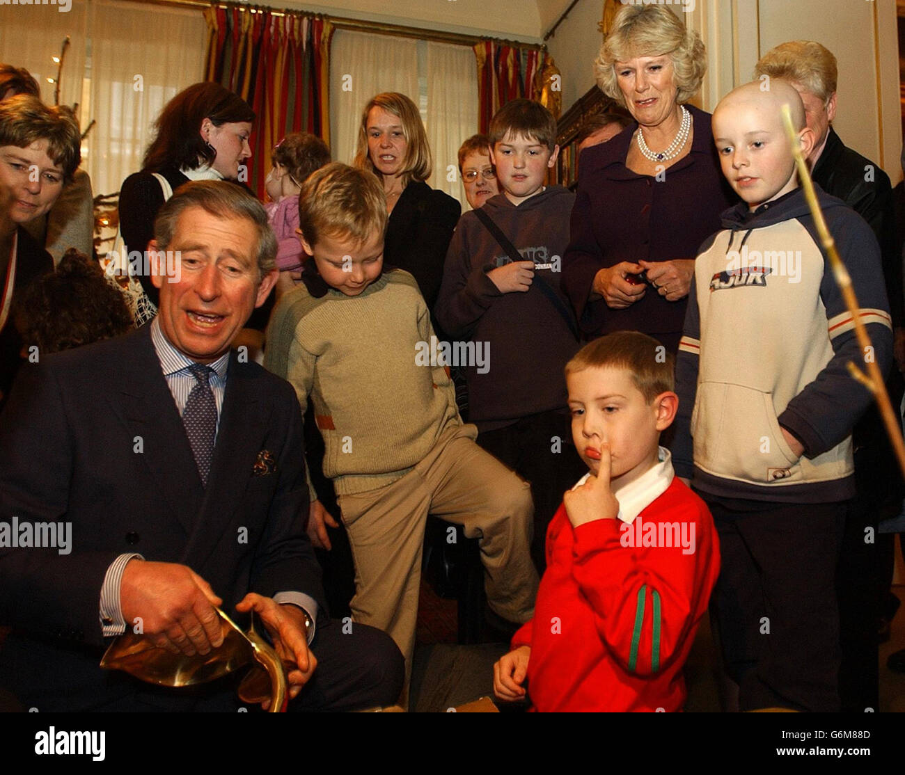 The Prince of Wales and Camilla Parker Bowles look at gifts at a ...