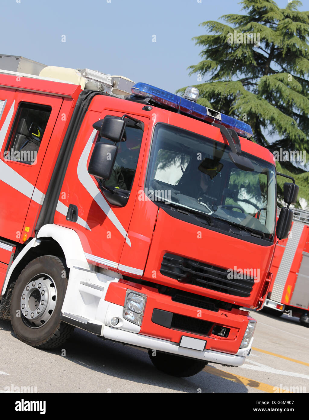 Red fire engine truck on the road after the emergency call Stock Photo ...