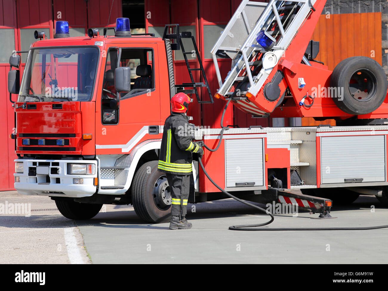 one firefighter with big red truck fire engines in the fire department ...