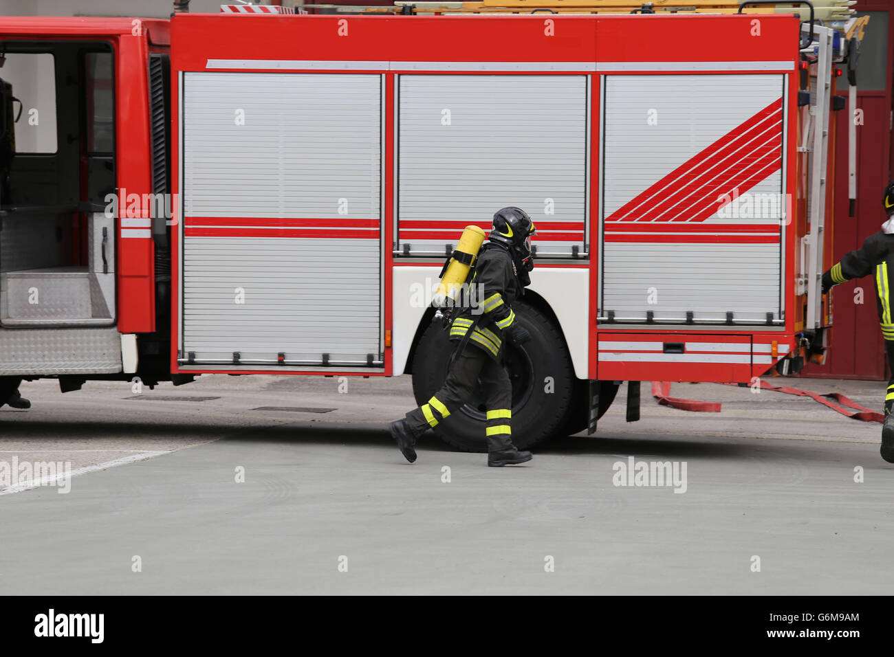 Firefighter running during a training exercise with the oxygen cylinder ...